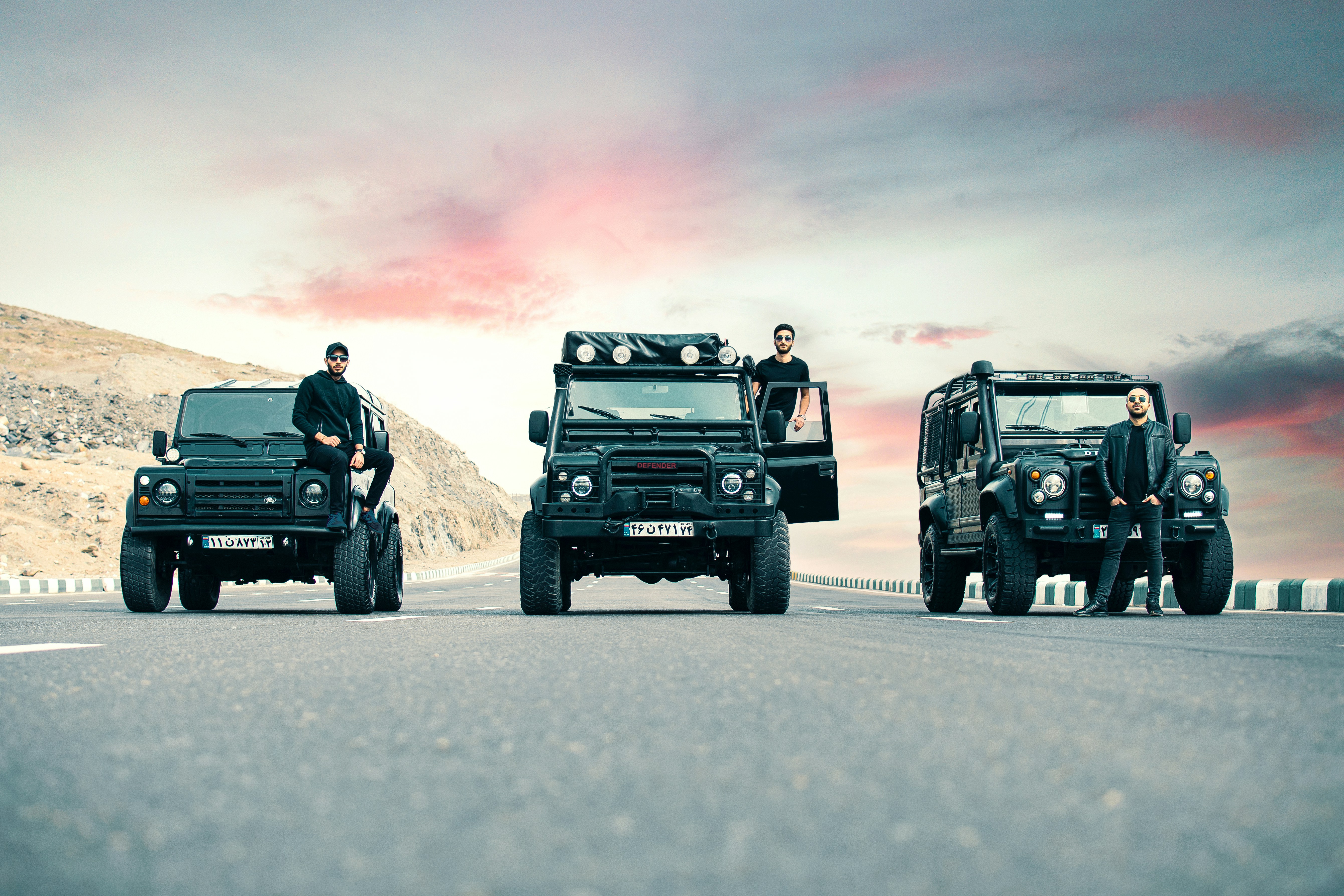2 men and woman riding on black jeep wrangler