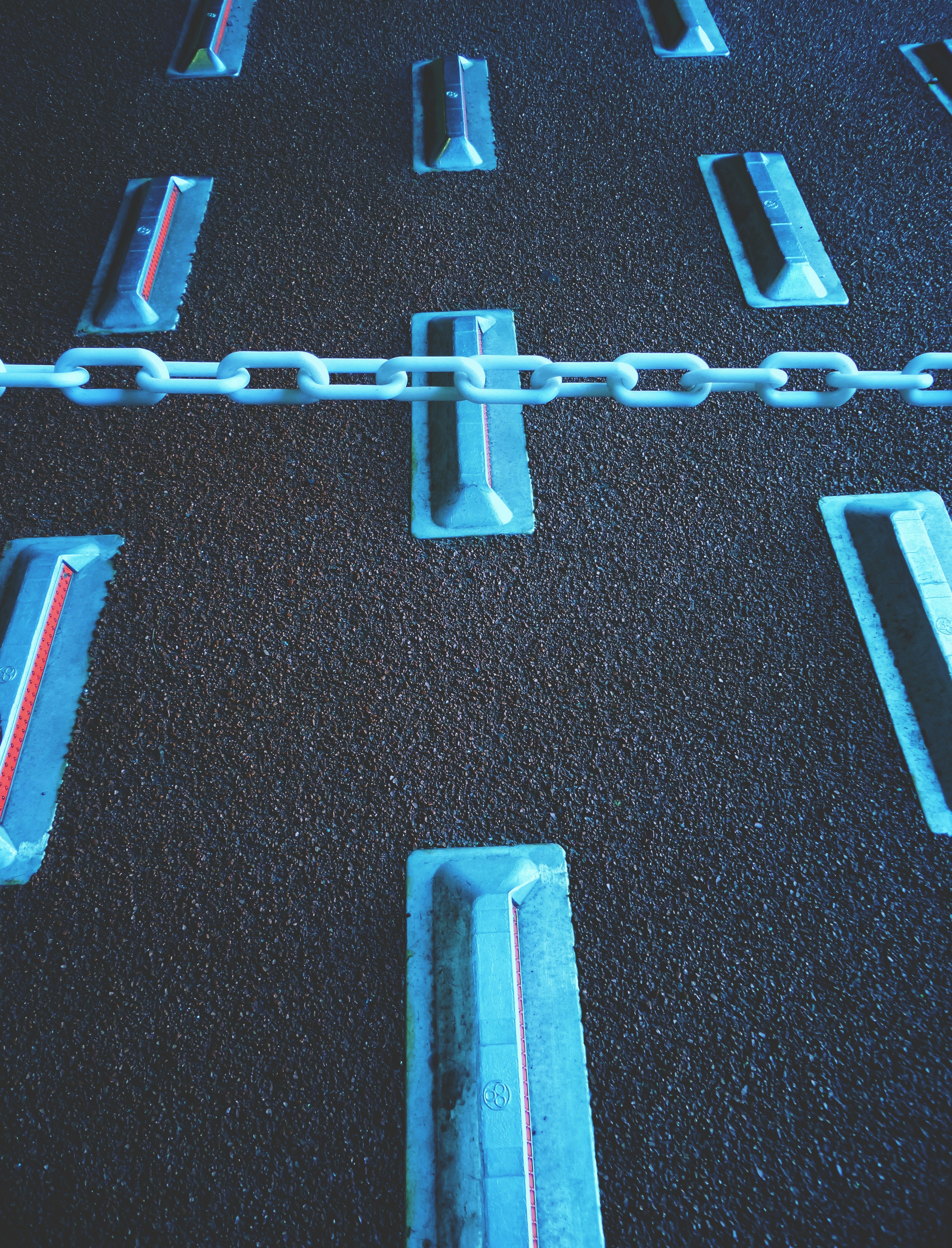 Blue Chain Across a Textured Asphalt Grid