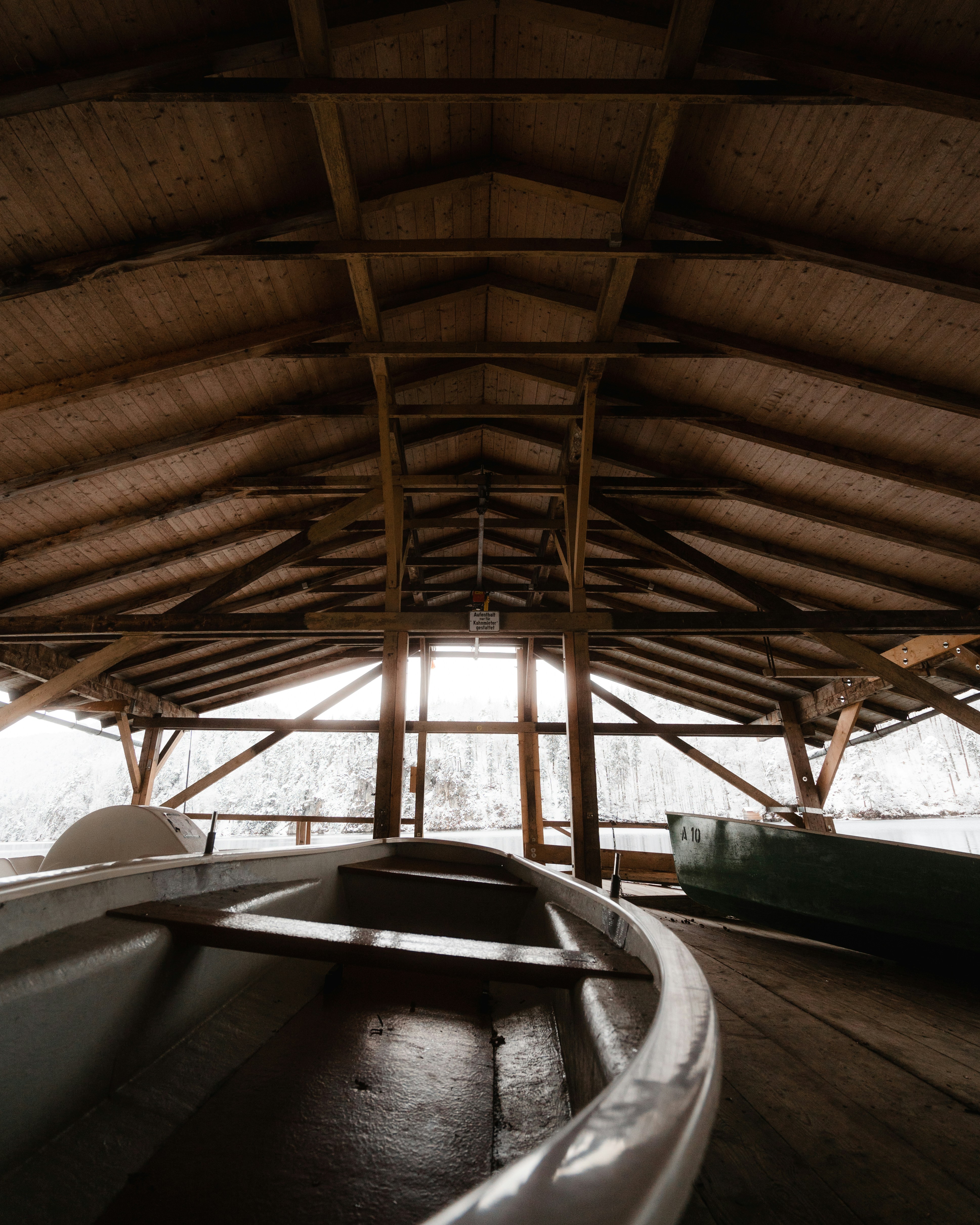 Sunlit Boat Shed: Symmetry, Timber, and Quiet harbor light