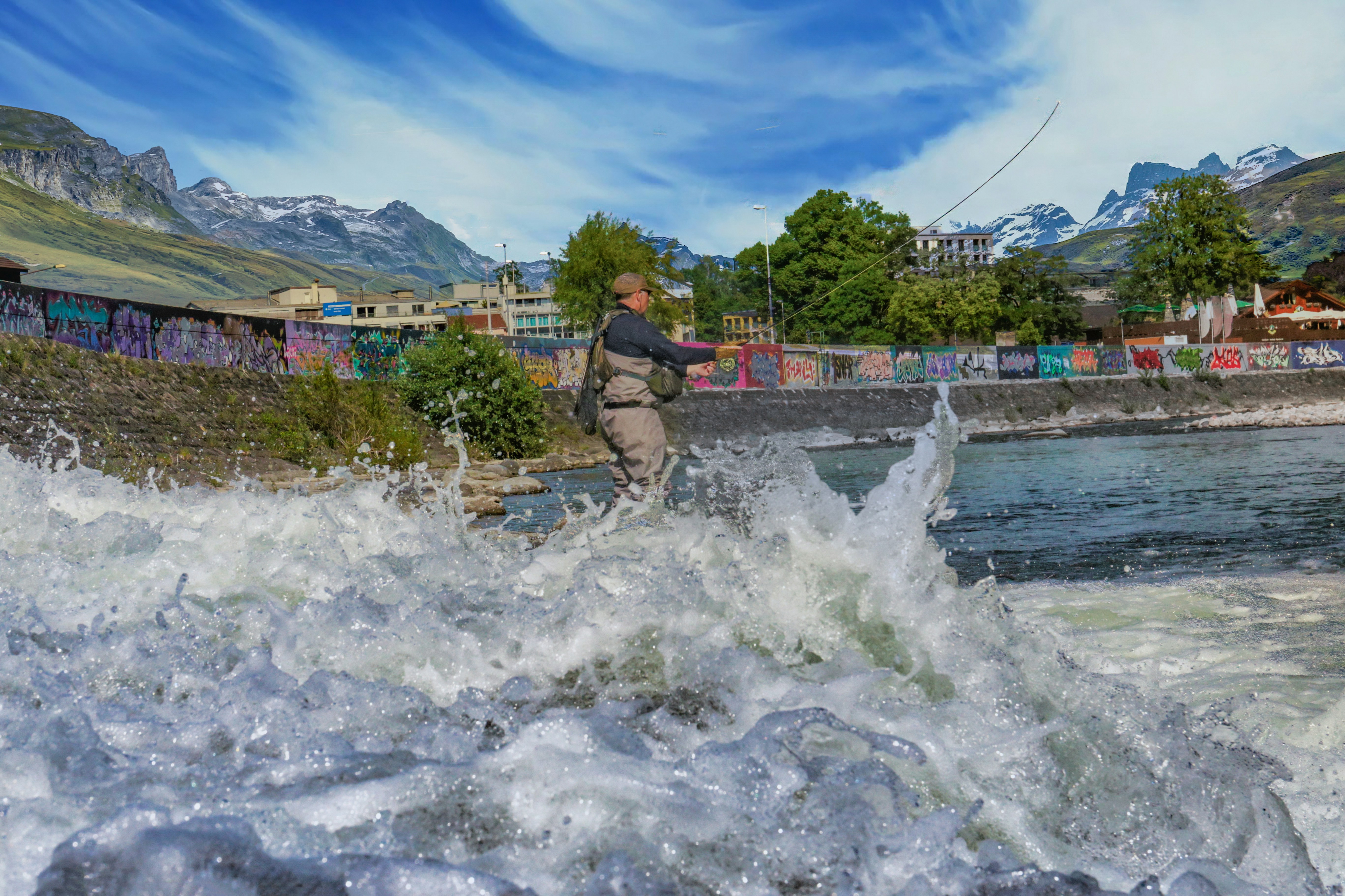 Spray and Skyline: Riverfront Portrait in a Graffiti-Walled Mountain Town
