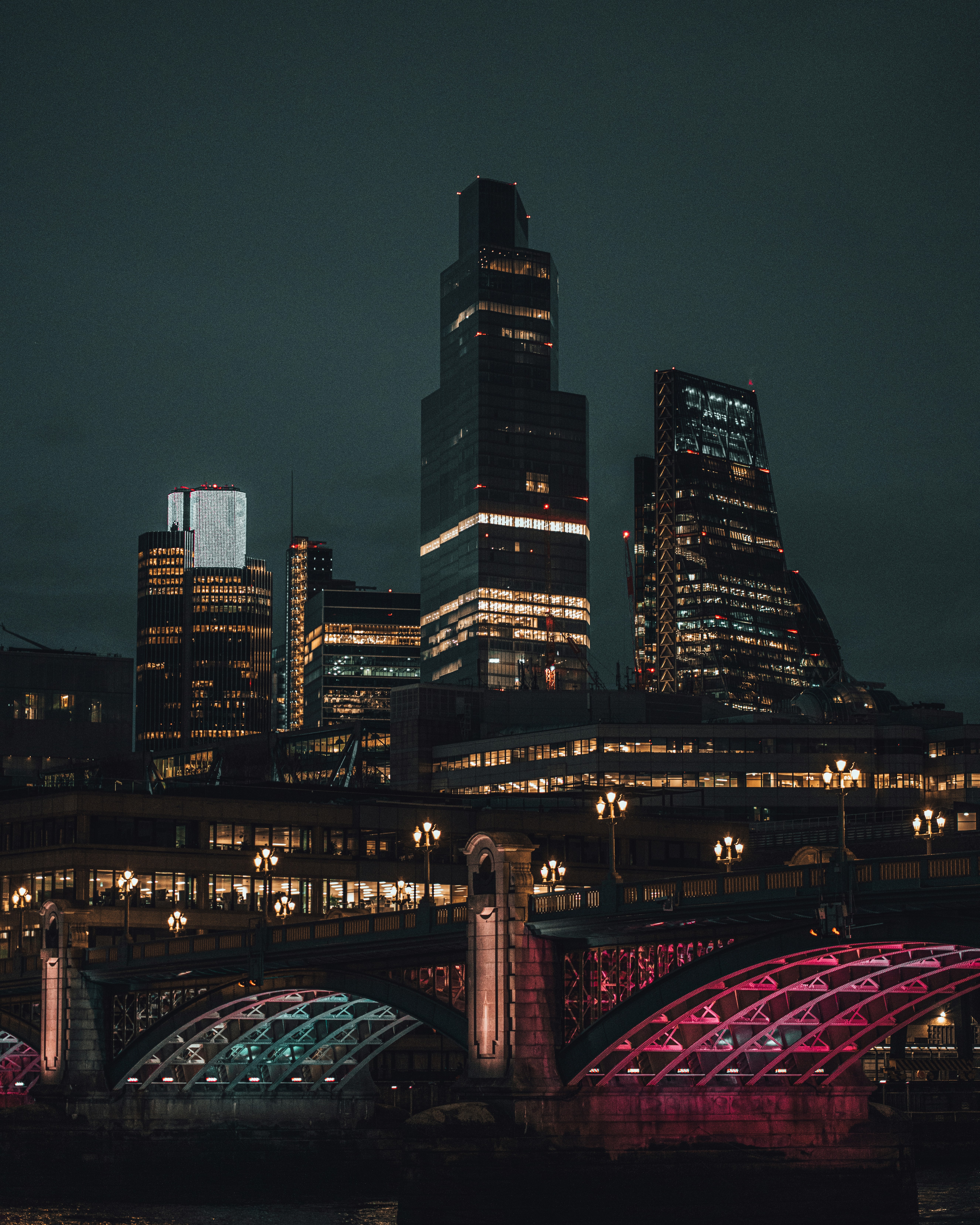 Lighted bridge over city skyline during night time photo – Free Street ...