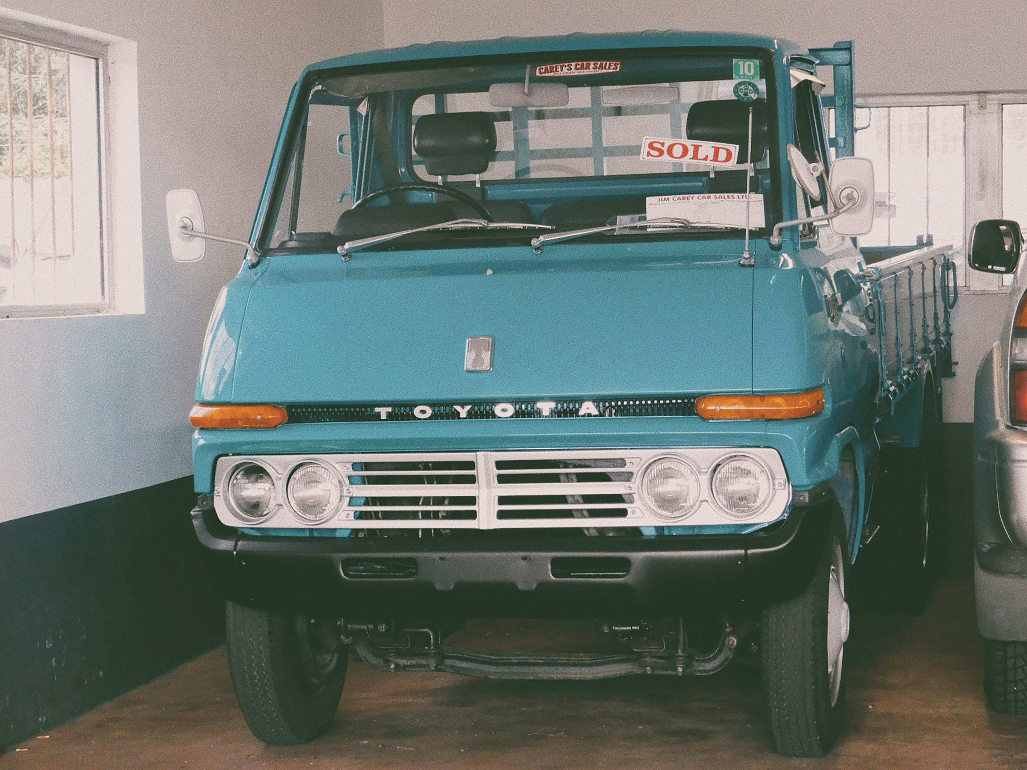 Blue Toyota Truck in a Quiet Garage: A Vintage Workhorse on Display