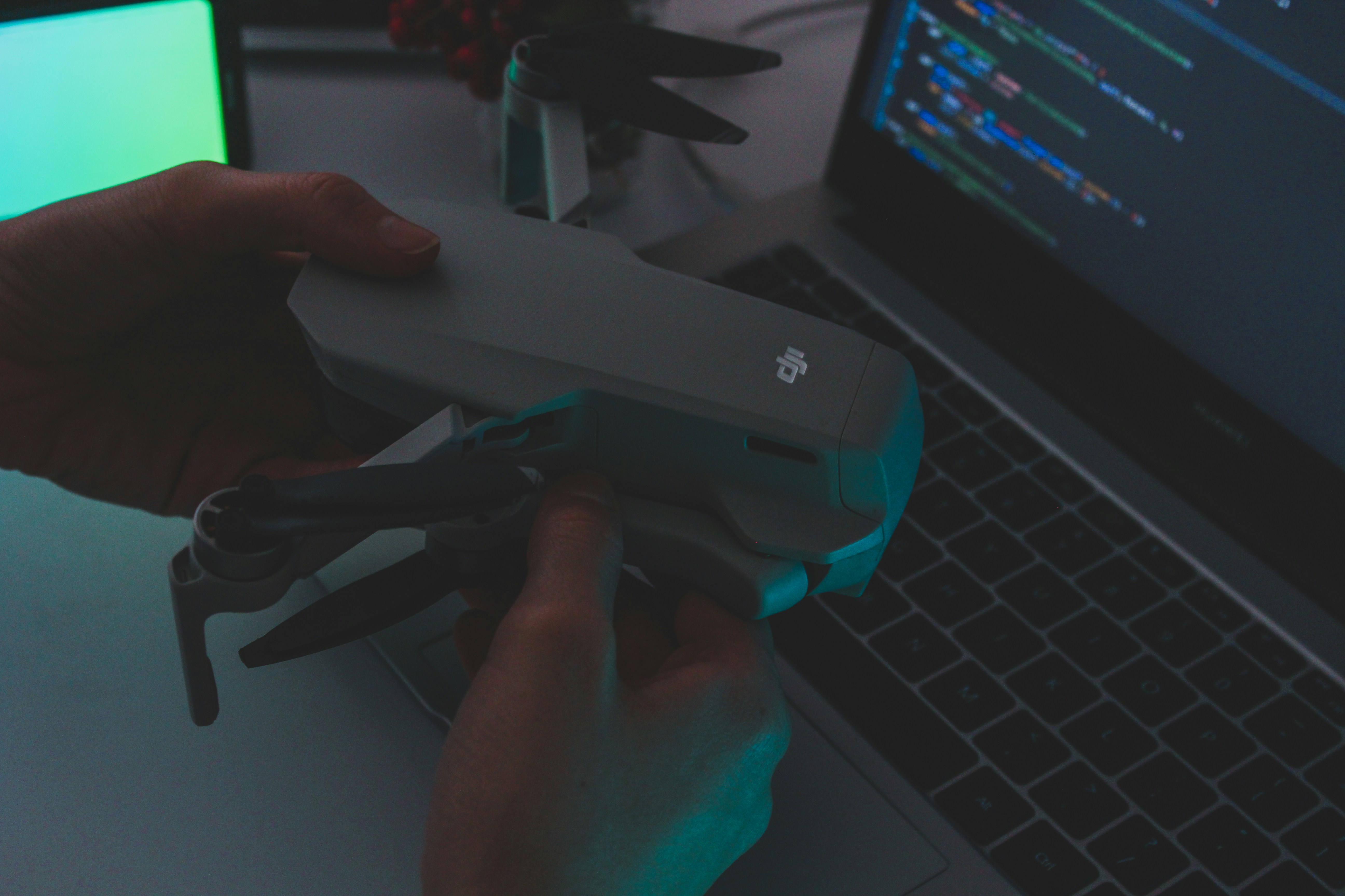A Quiet Pulse: Drone Controller and Laptop in Dim Studio Light