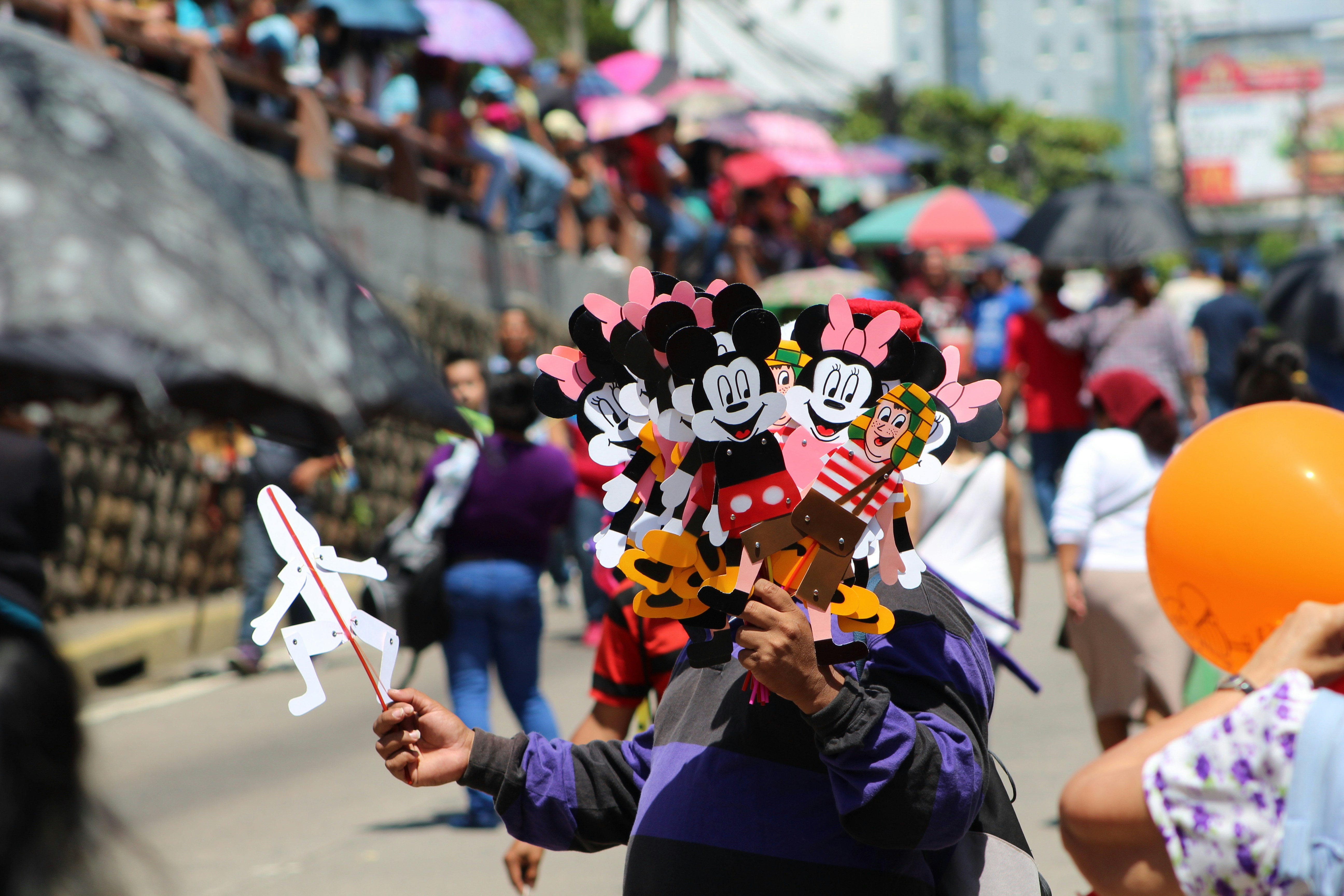 Mickey Mask in the Midst: A Colorful City Parade