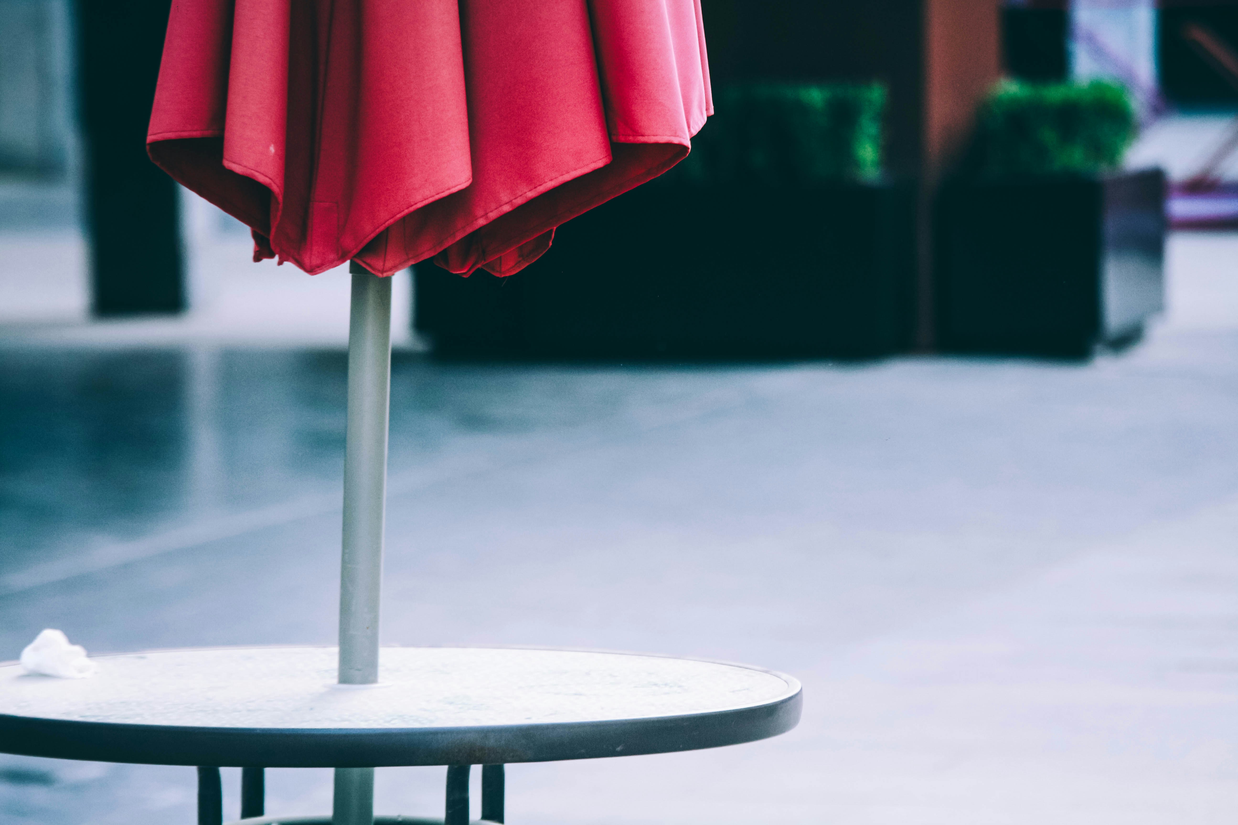 Crimson Canopy over a Quiet Courtyard Table