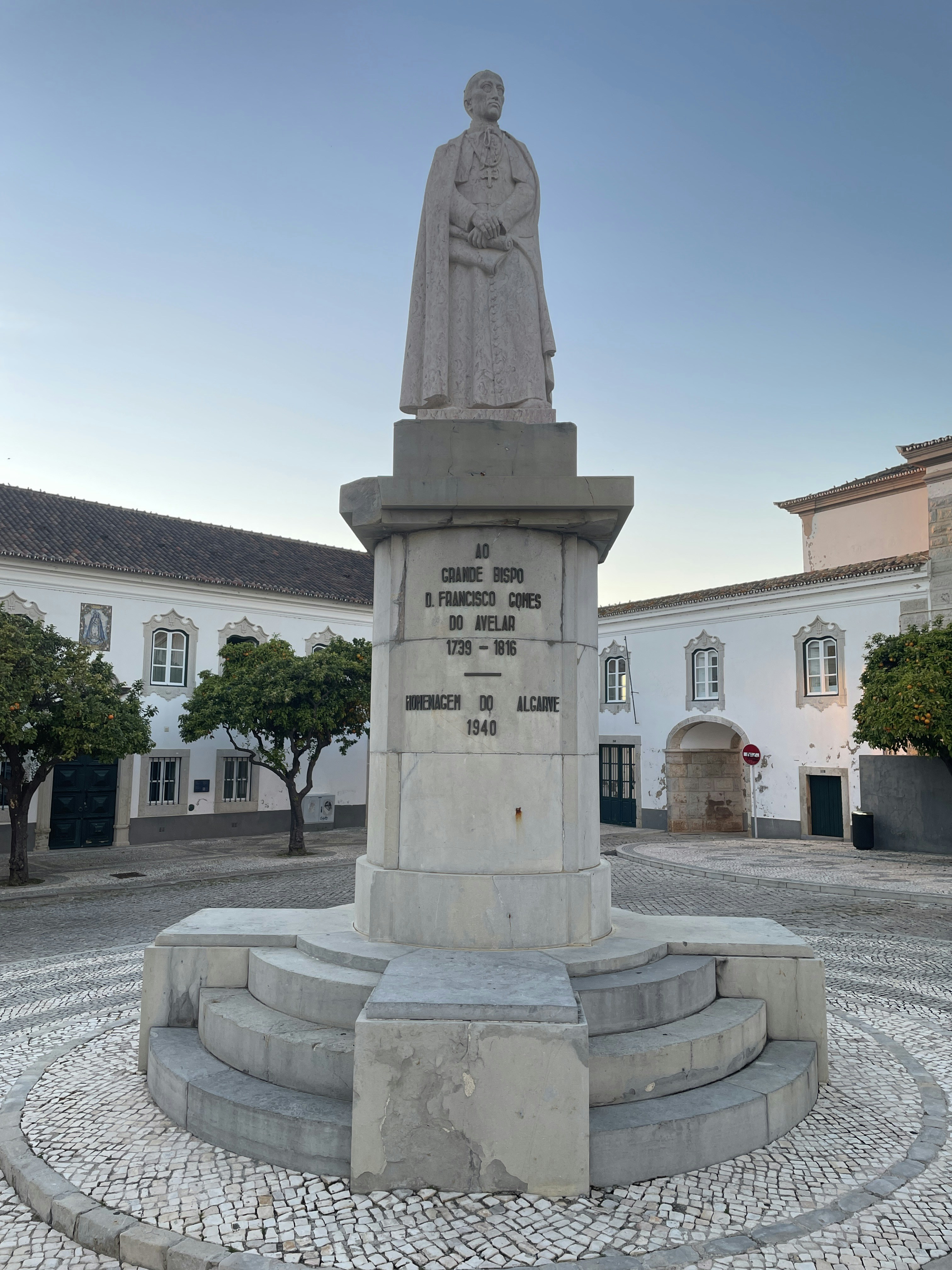 Monument honoring D. Francisco Gomes de Villalar, featuring a statue atop a marble pedestal in a serene plaza.