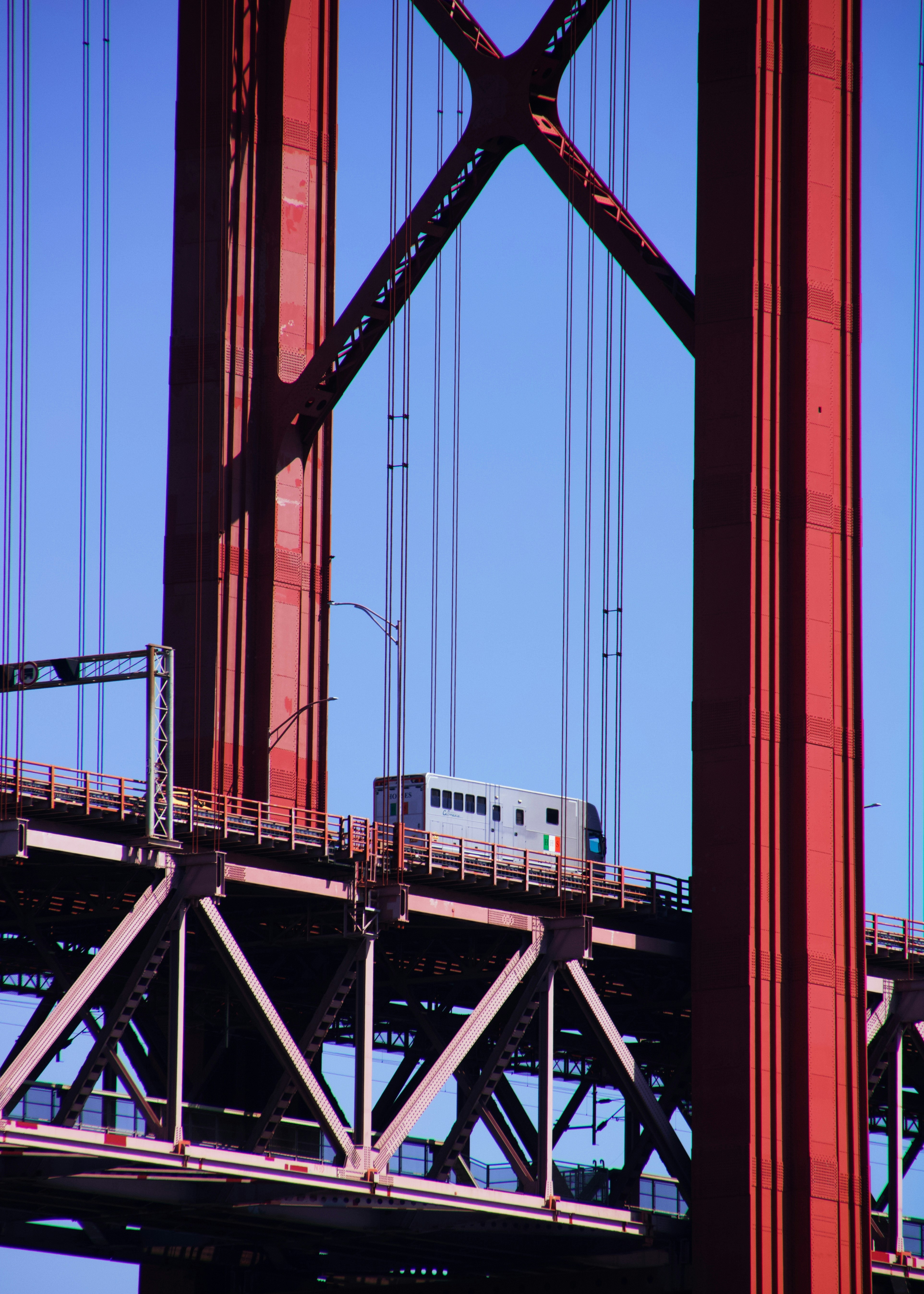 Crimson Arches: A lone railcar crossing the span
