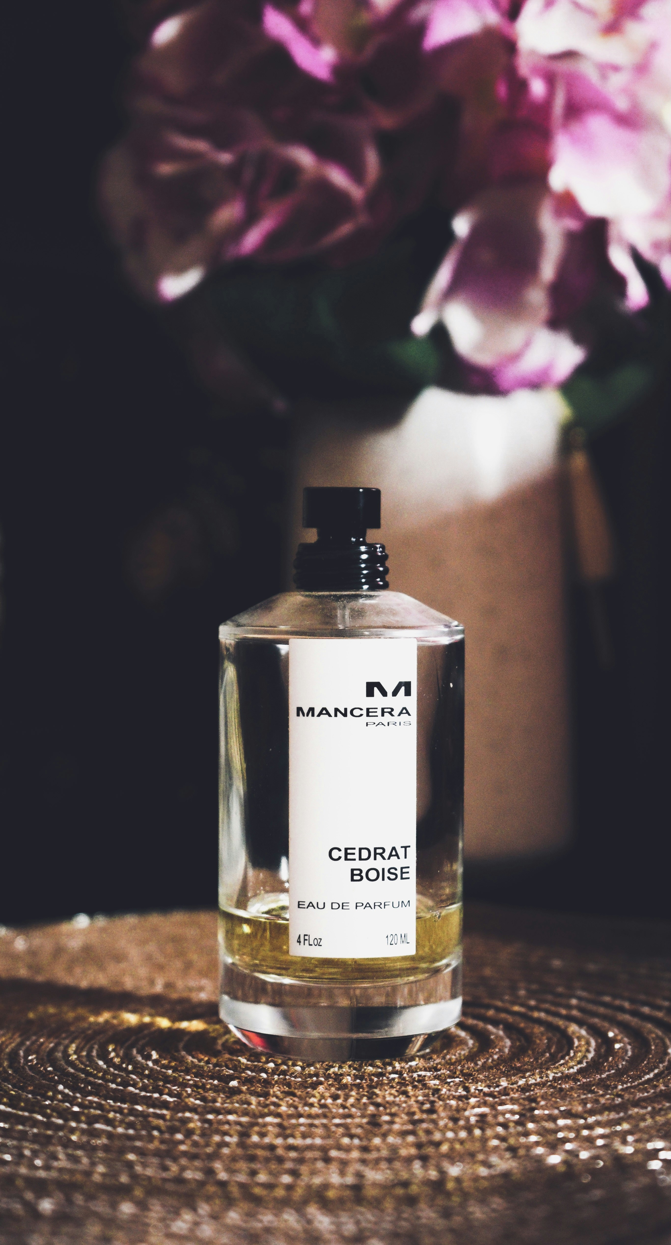 Petal Crown in Glass: Cedar Boise Perfume on a Rustic Table