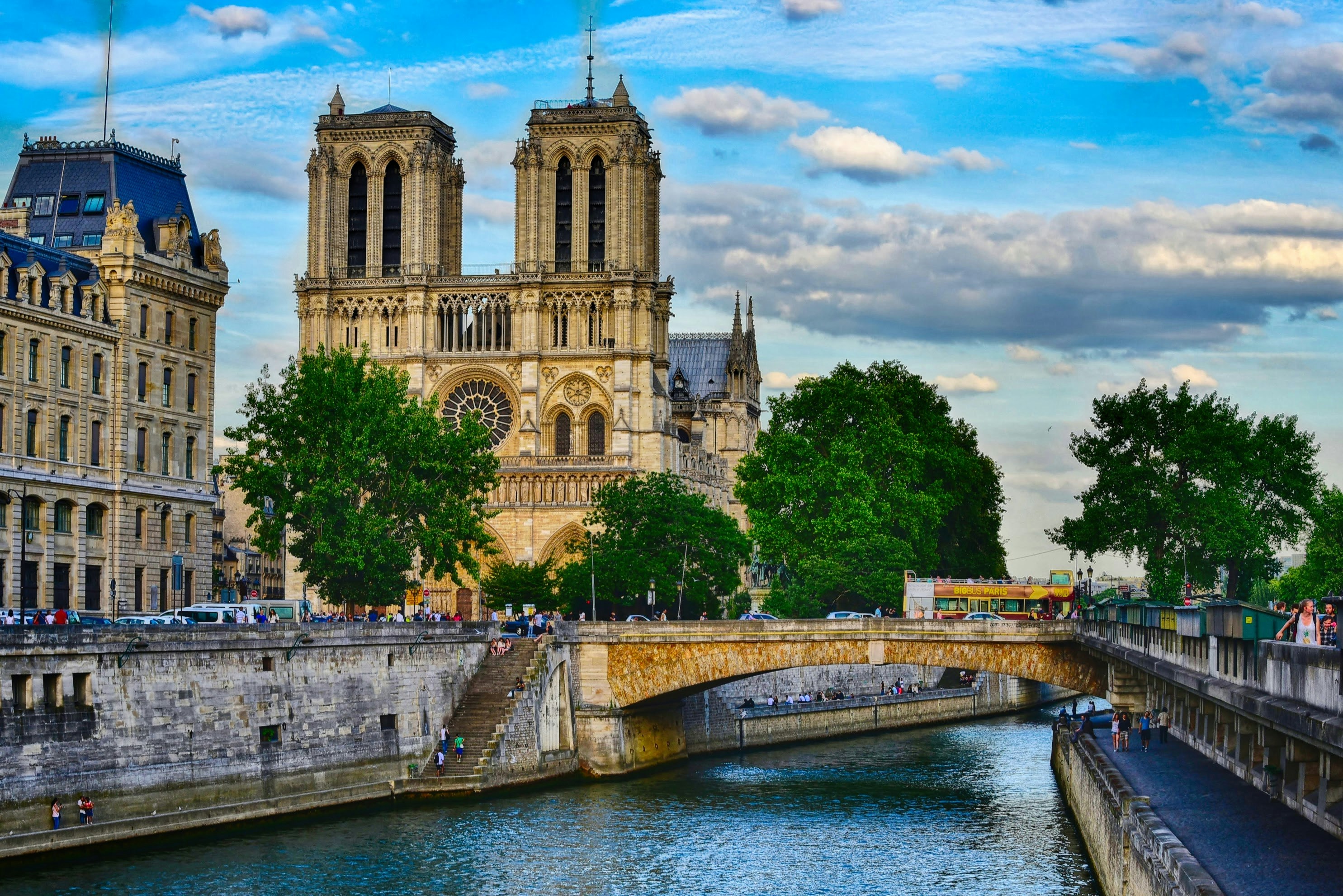 Brown concrete building near bridge under blue sky during daytime photo ...