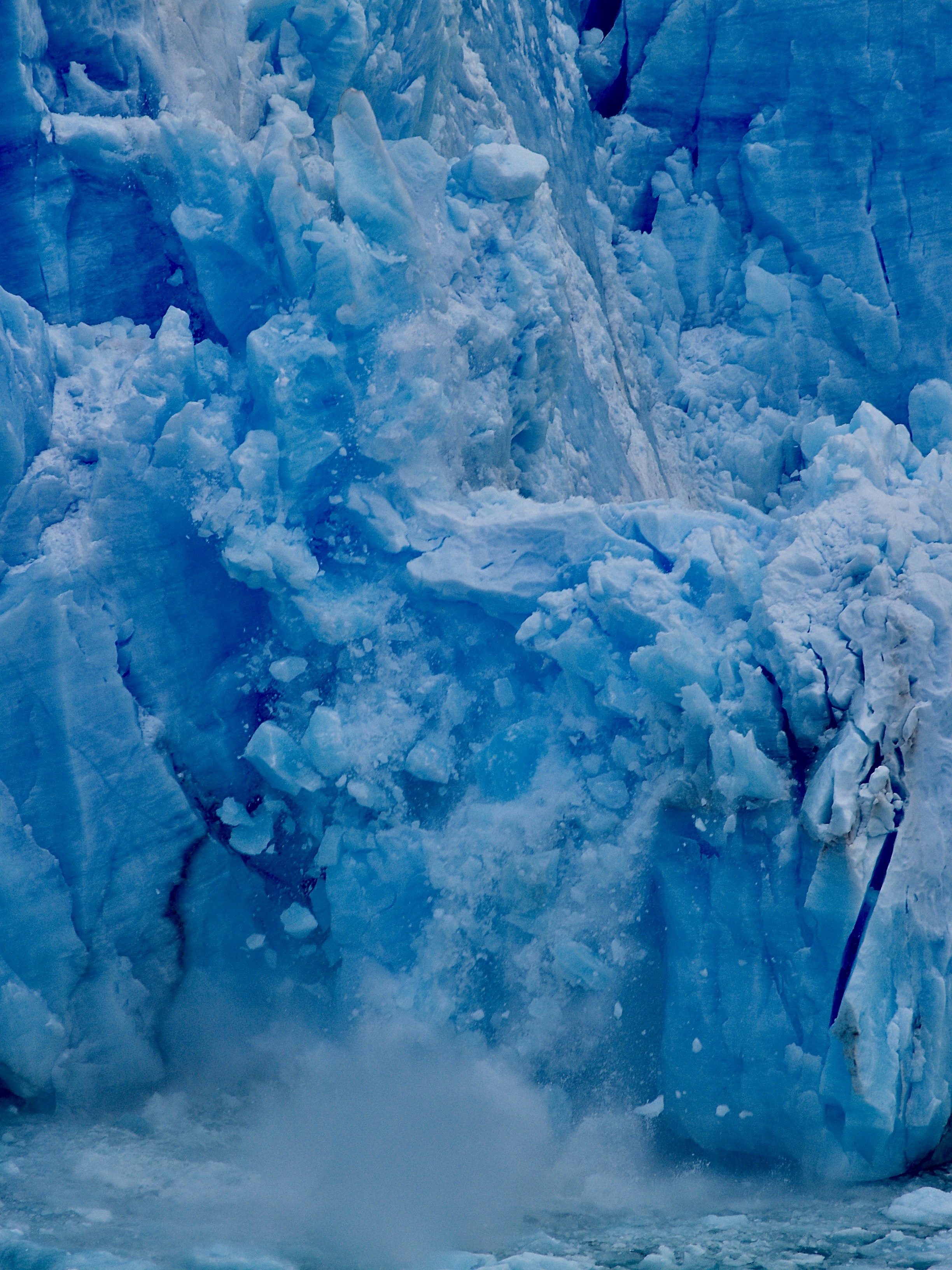Massive glacier with intricate blue ice formations and dynamic textures, showcasing the power of nature's forces.