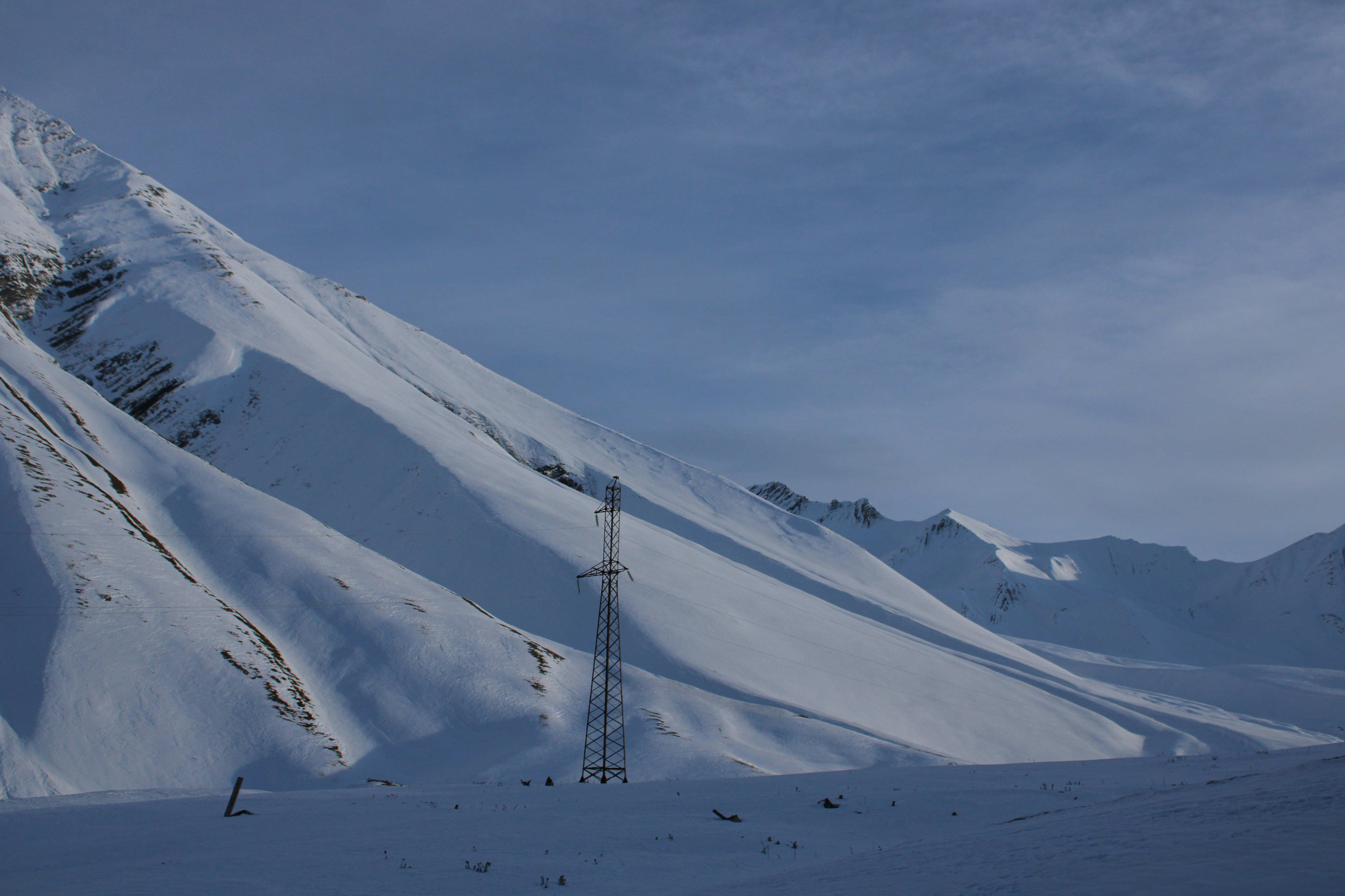Snow covered mountain under cloudy sky during daytime photo – Free ...