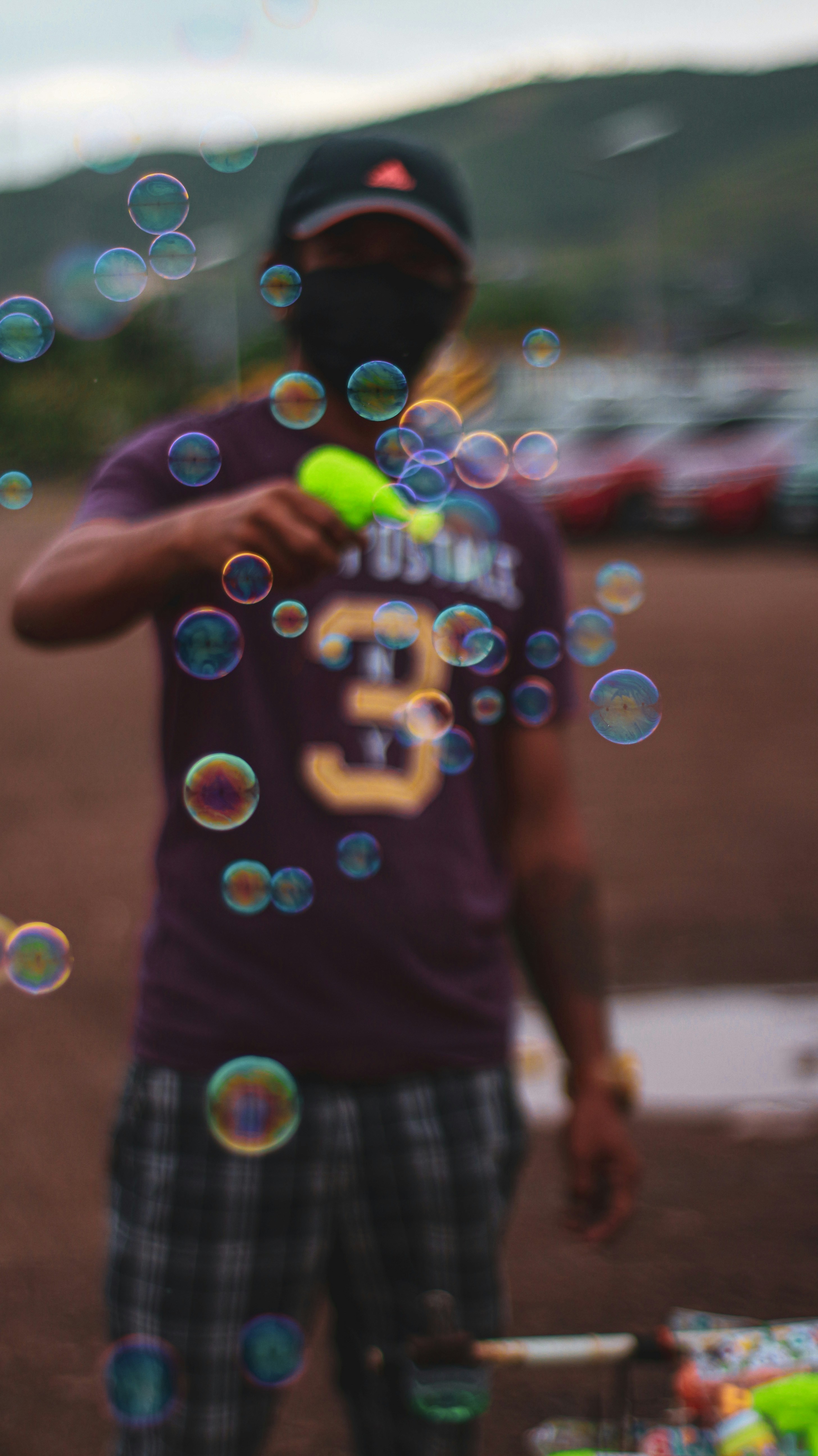 person playing bubbles during daytime
