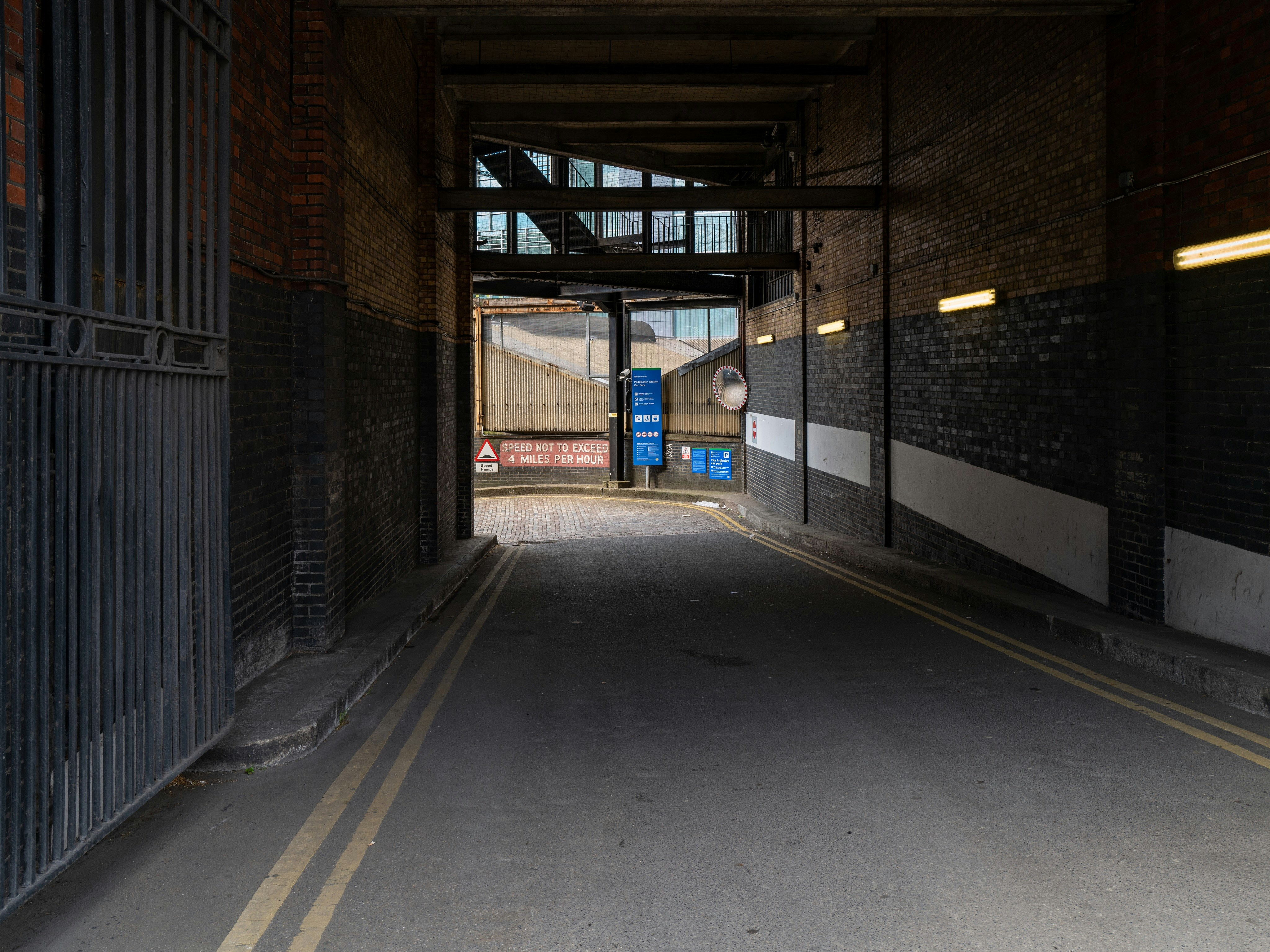 Brick Corridor to the Light: An Urban Underpass Framed in Shadow