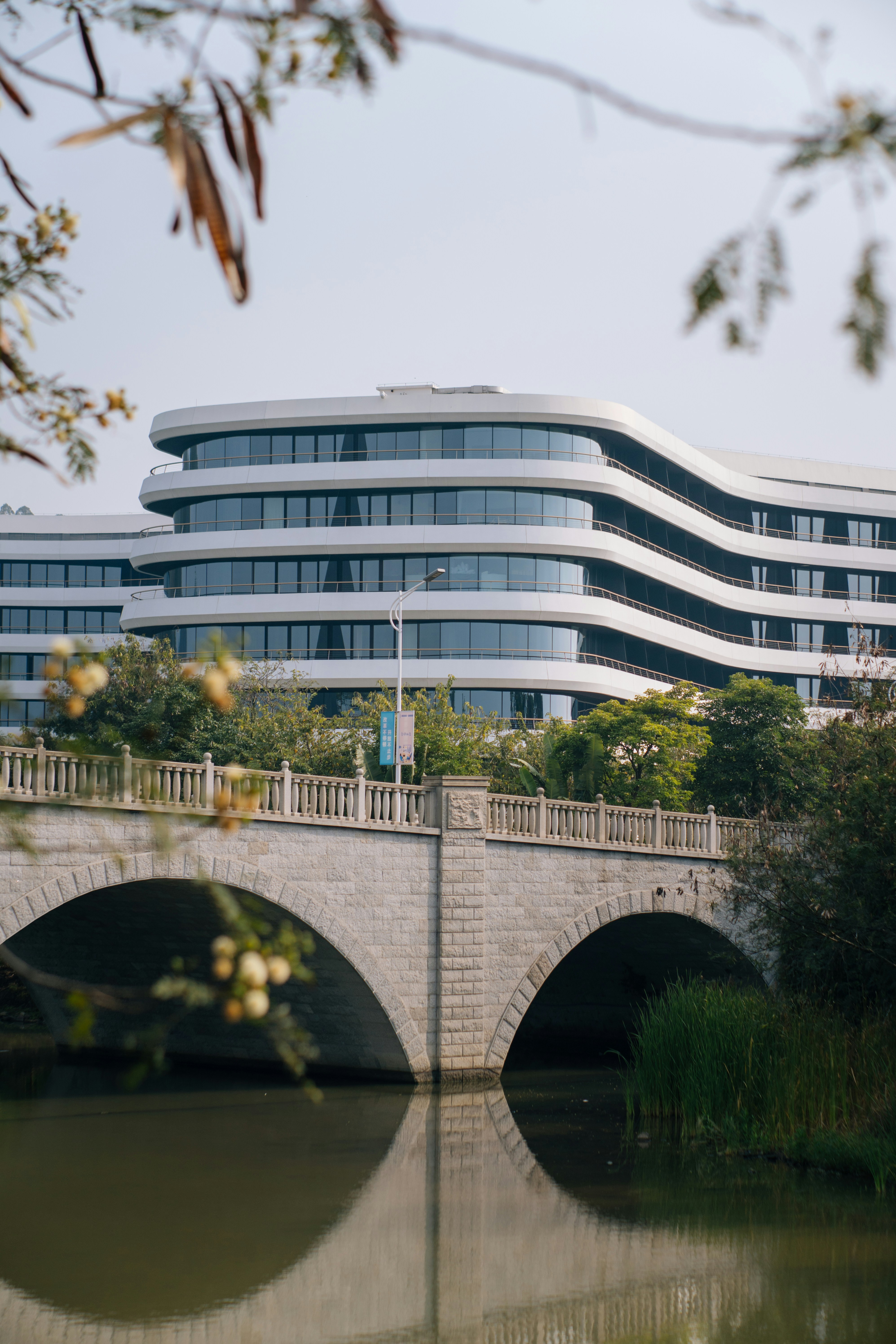 Curved Glass Arcades Over the River
