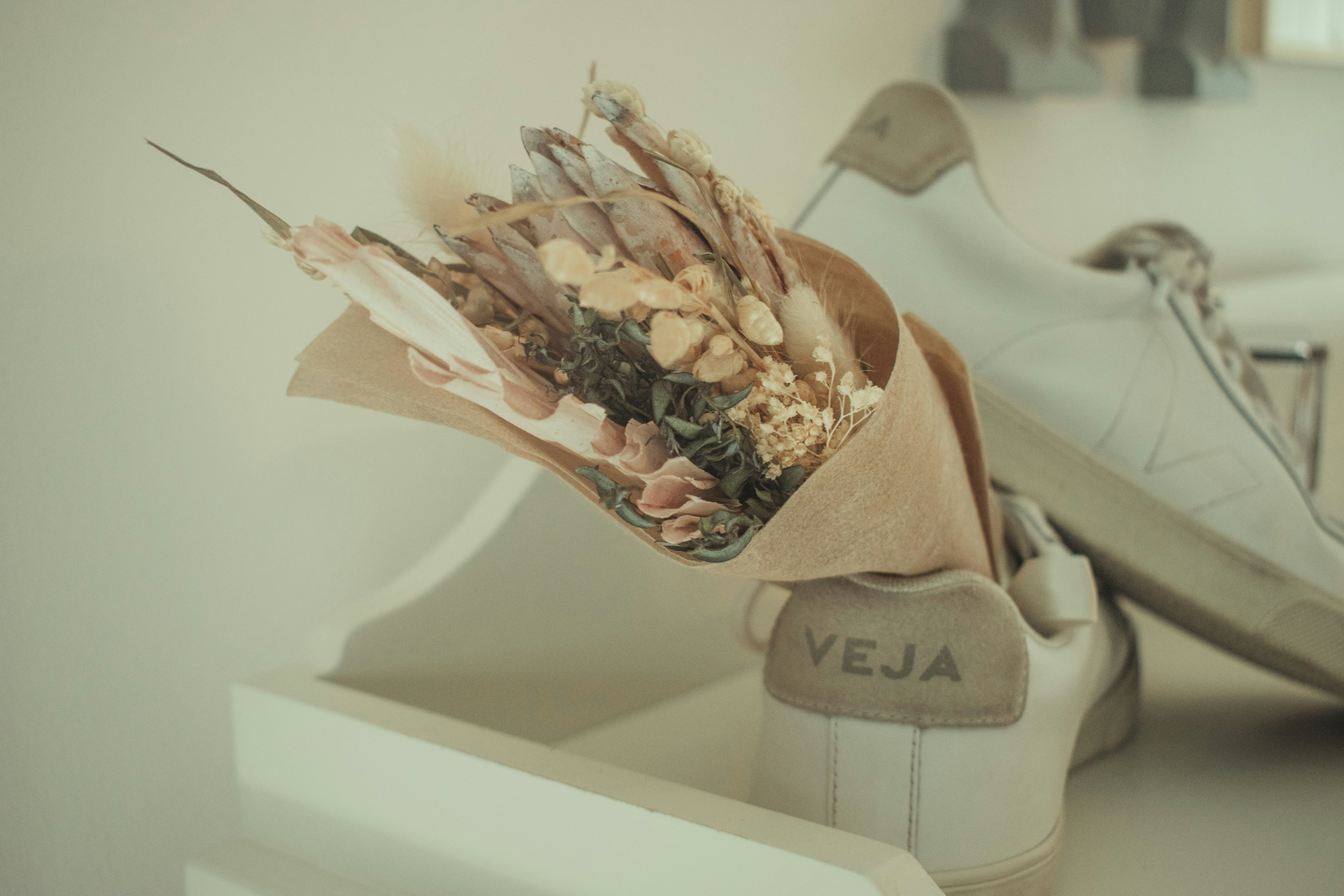 Bouquet and Sneakers: Soft Vintage Quiet in a Shoe Display