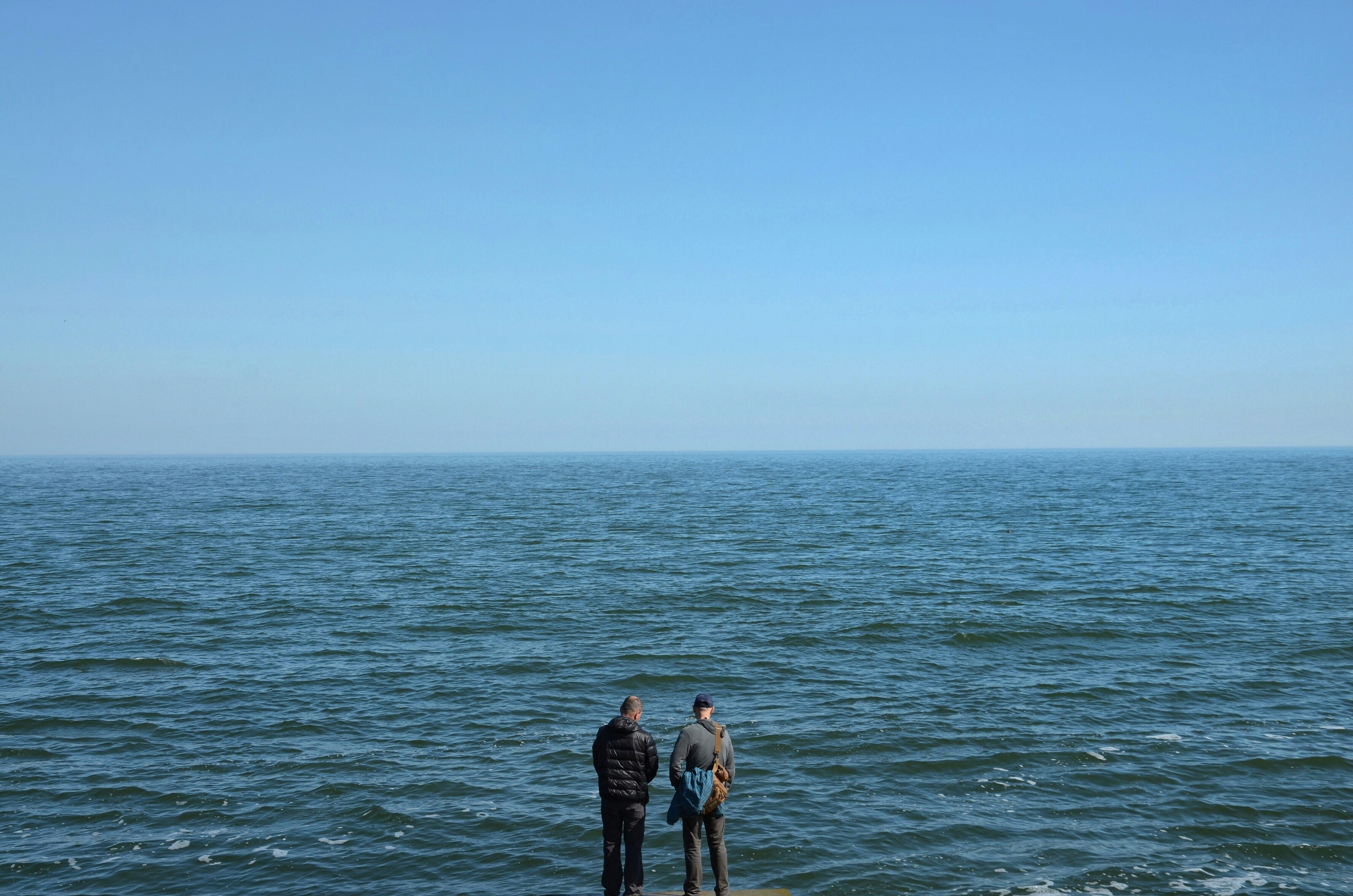 Low Tide Dialogues: Two Figures at the Sea's Edge