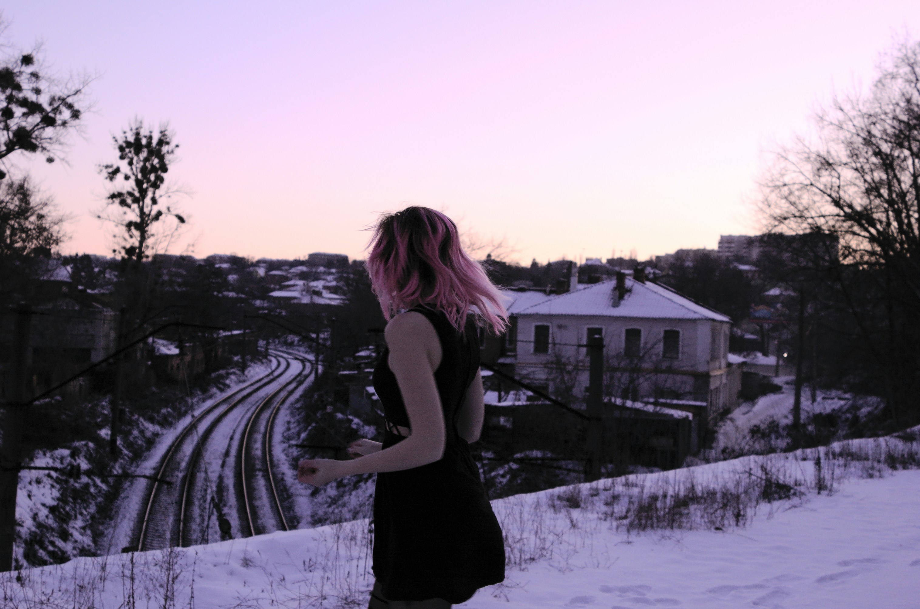 Dusk on the Rails: A lone figure in snowbound twilight