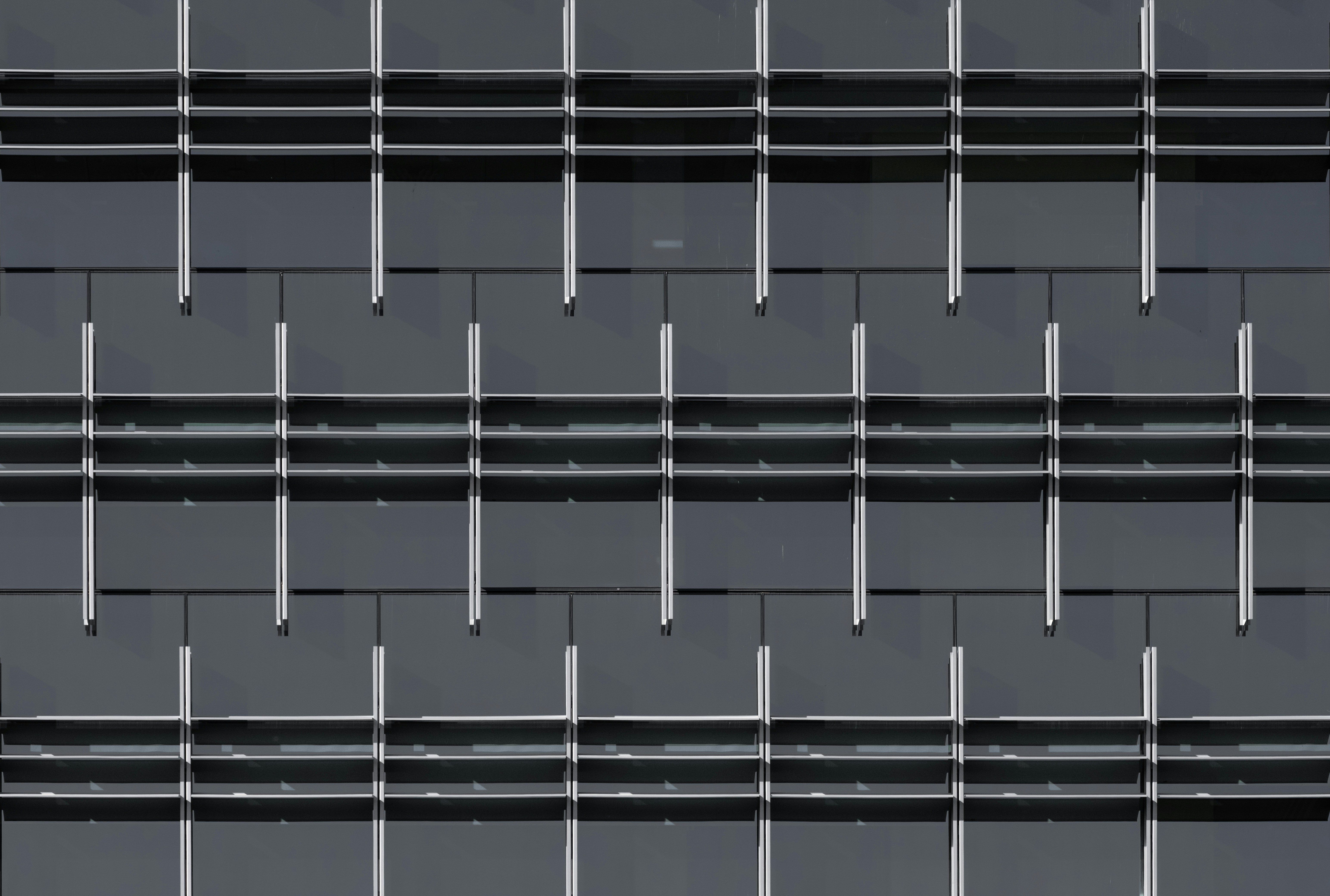 Rhythmic Facade: Monochrome Grid of Horizontal Louvers and Vertical Posts