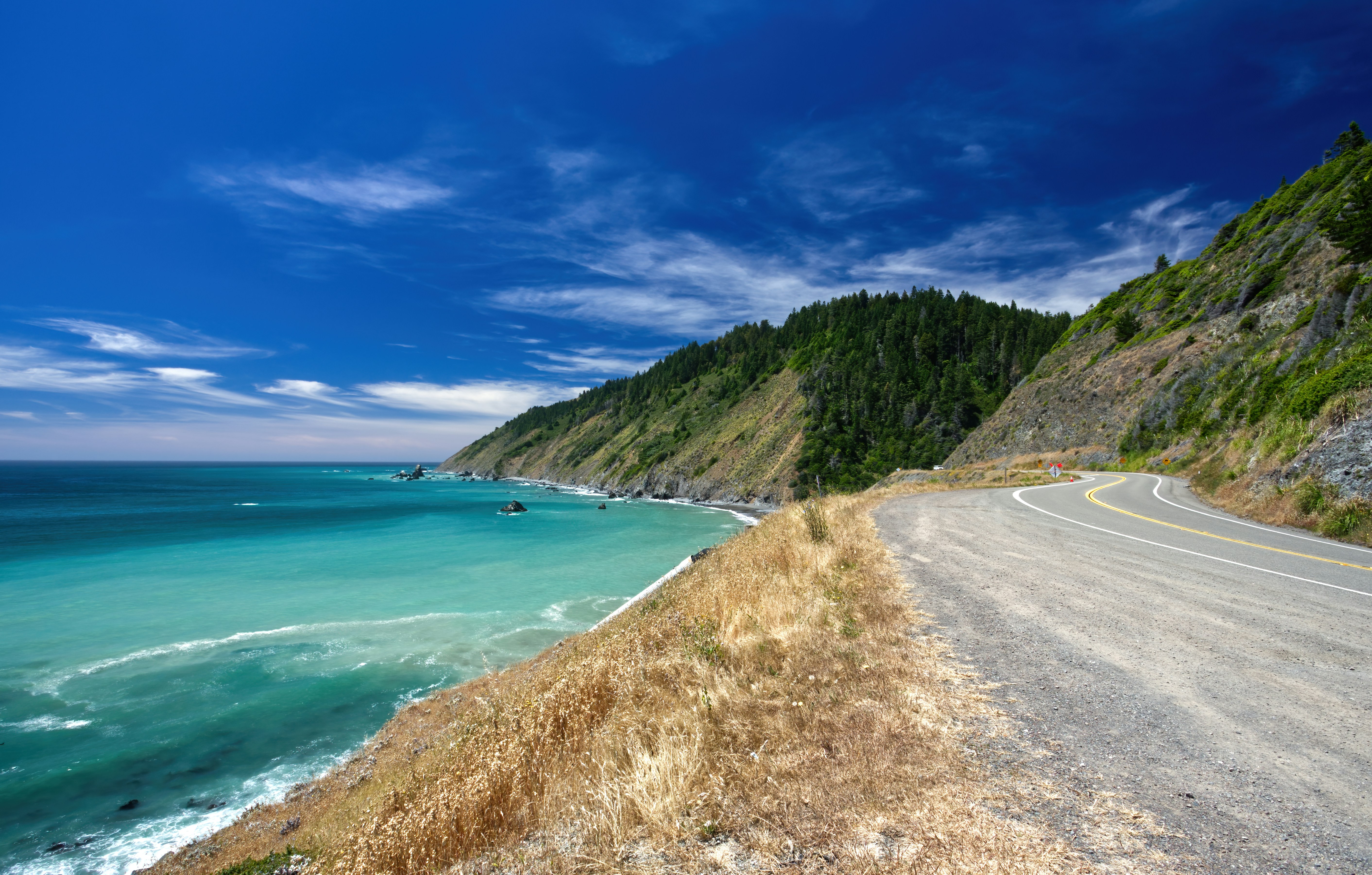 Curved Coastline: A Quiet Road Skirting Turquoise Cliffs