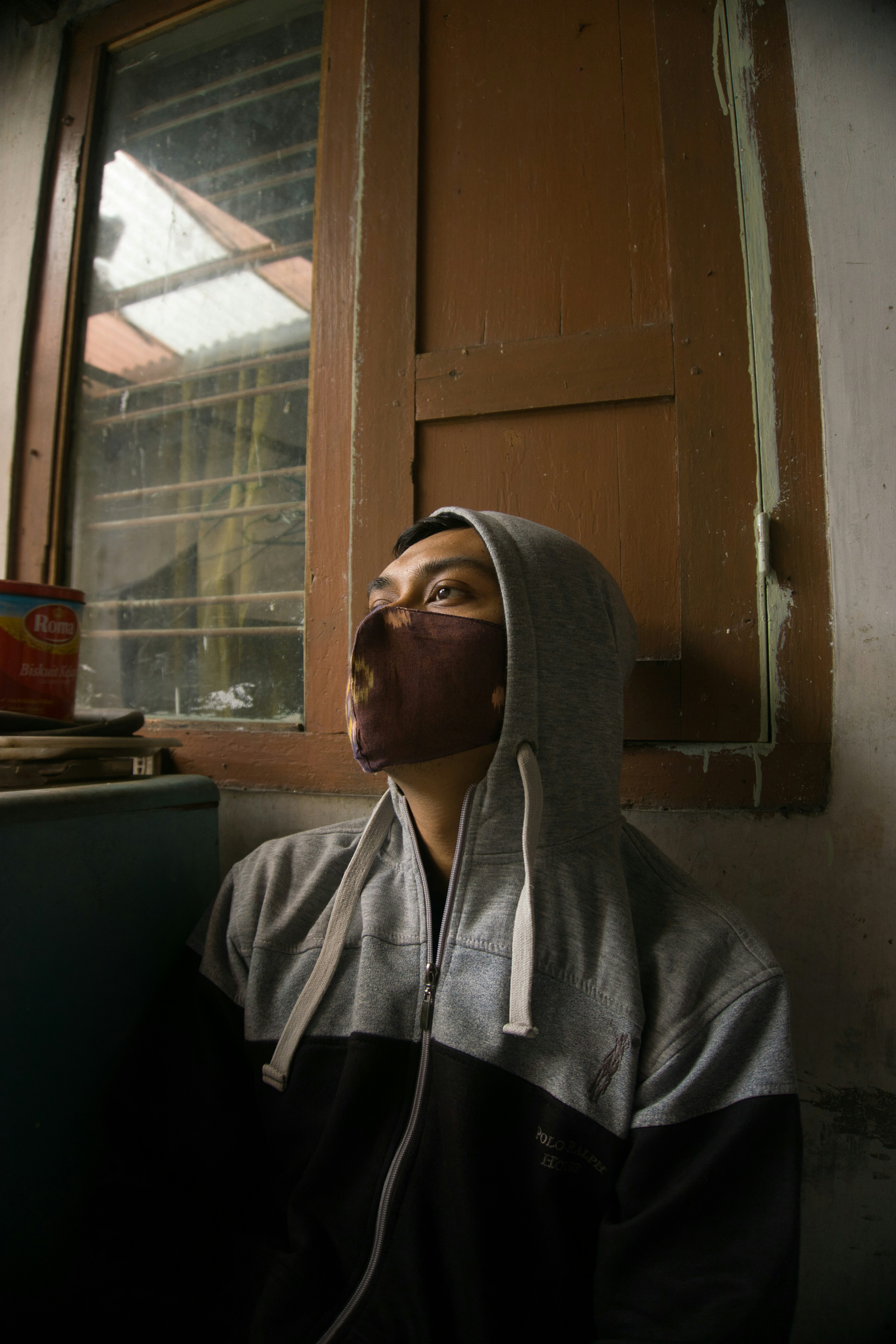 Hooded Quiet in a Dim Kitchen