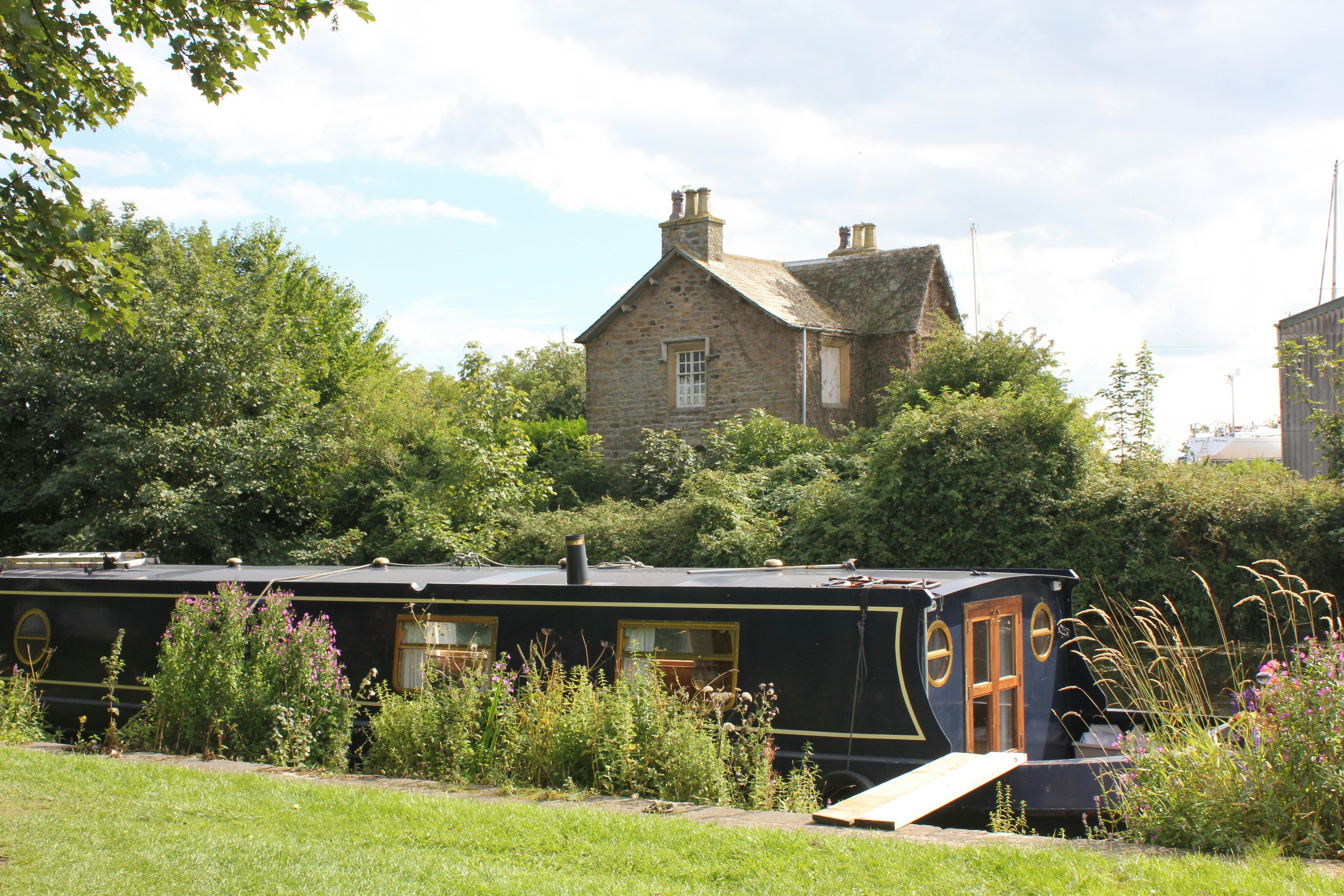 Serene Canal Journey Past a Rustic Cottage