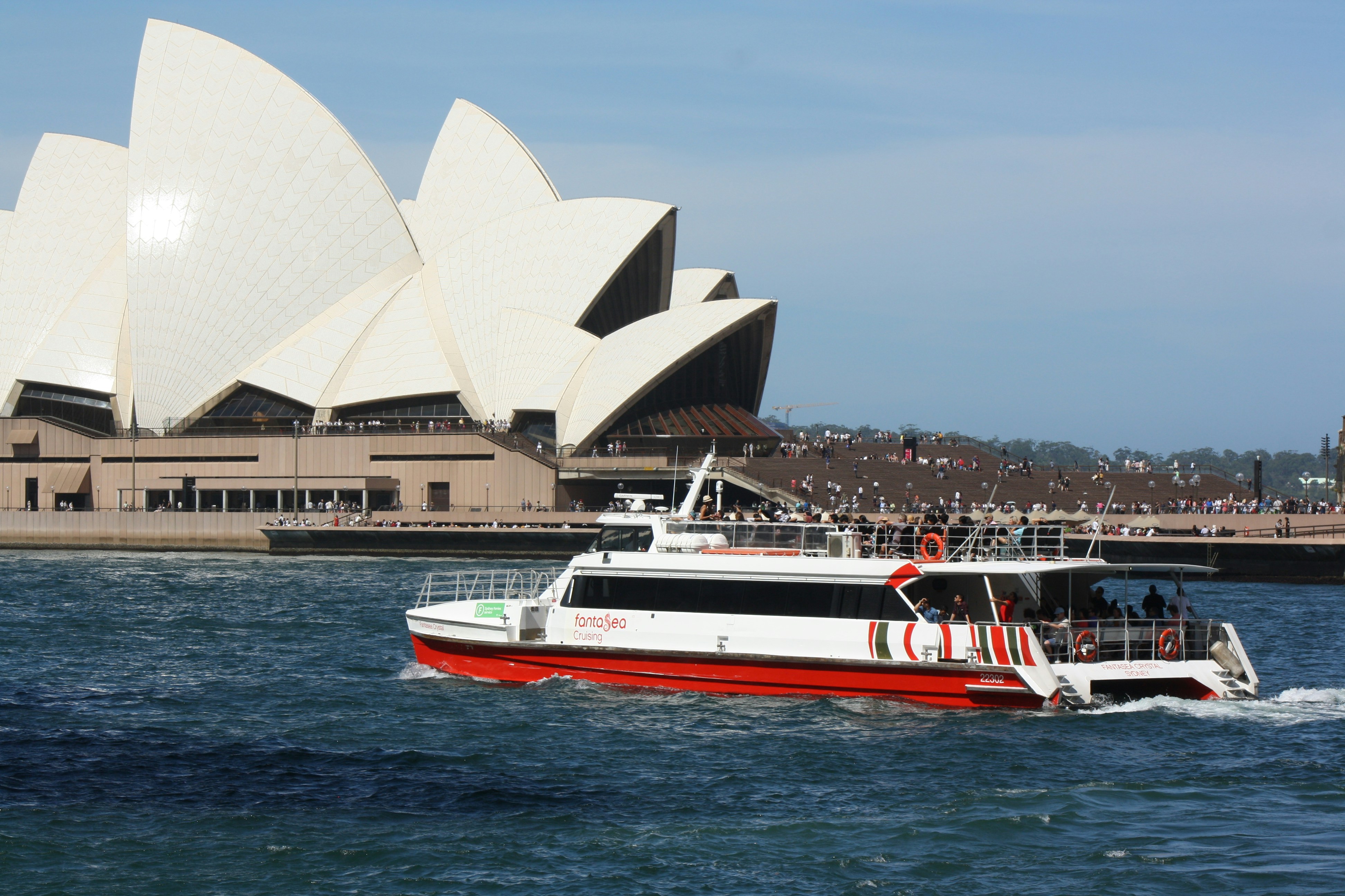 Harbor Ballet: Opera House in the Wake of a Crimson Ferry