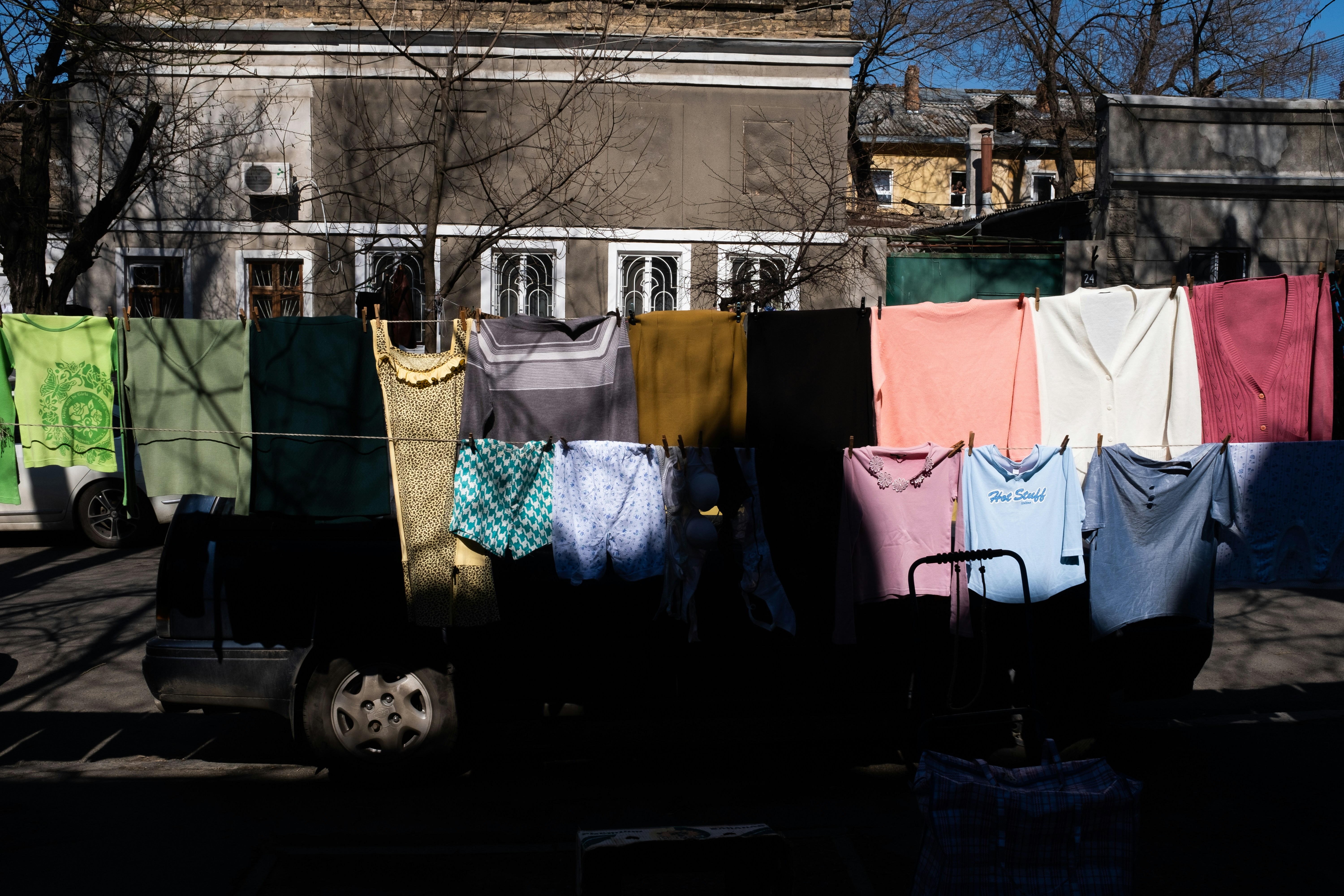 Chromatic Laundry Parade Across a Sunlit Urban Street