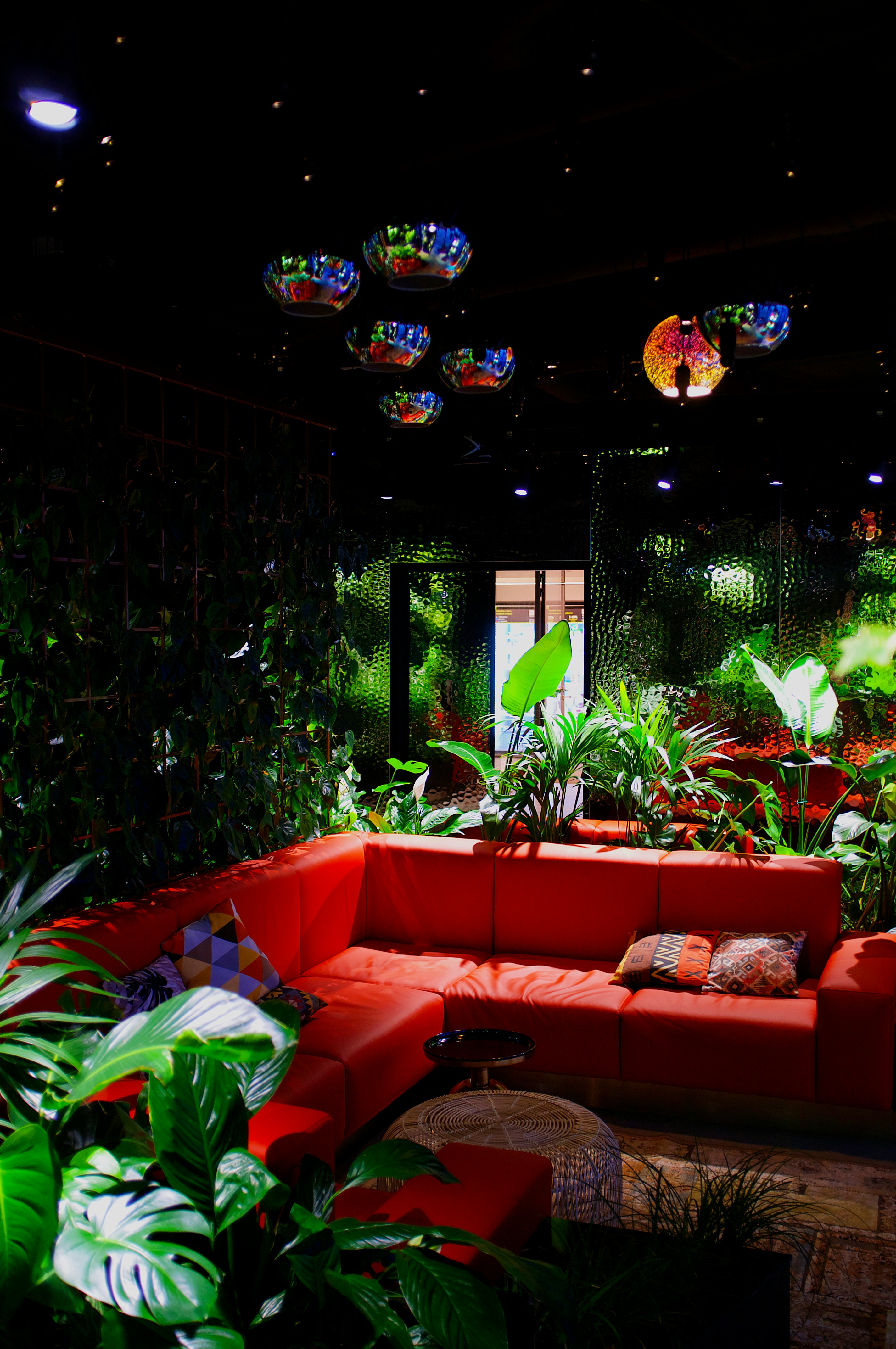 Crimson Corner: A Cozy Lounge Immersed in Greenery and Colorful Glass Orbs