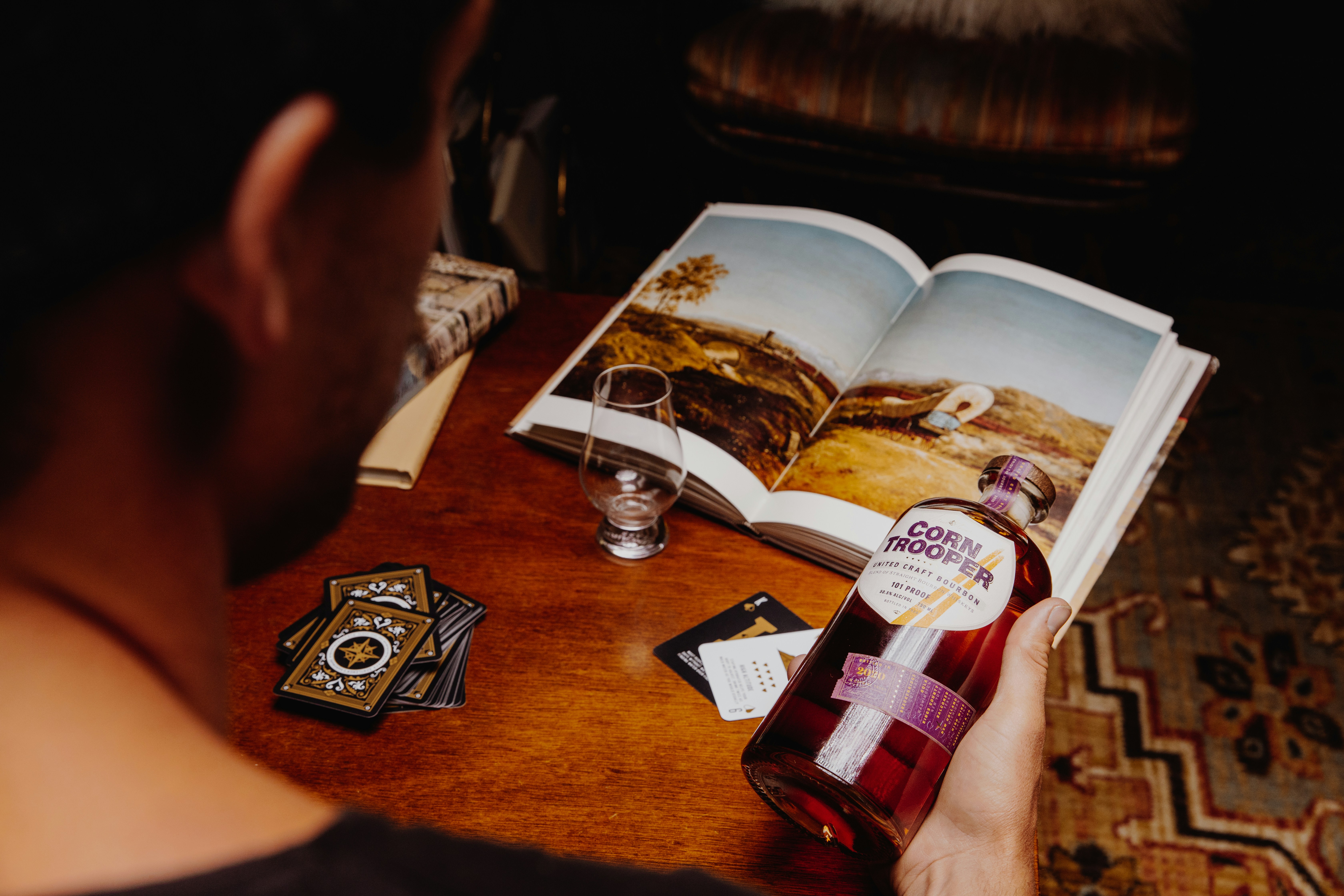 The Quiet Ritual: A Closer Look at a Bottle in a Card-Game Corner