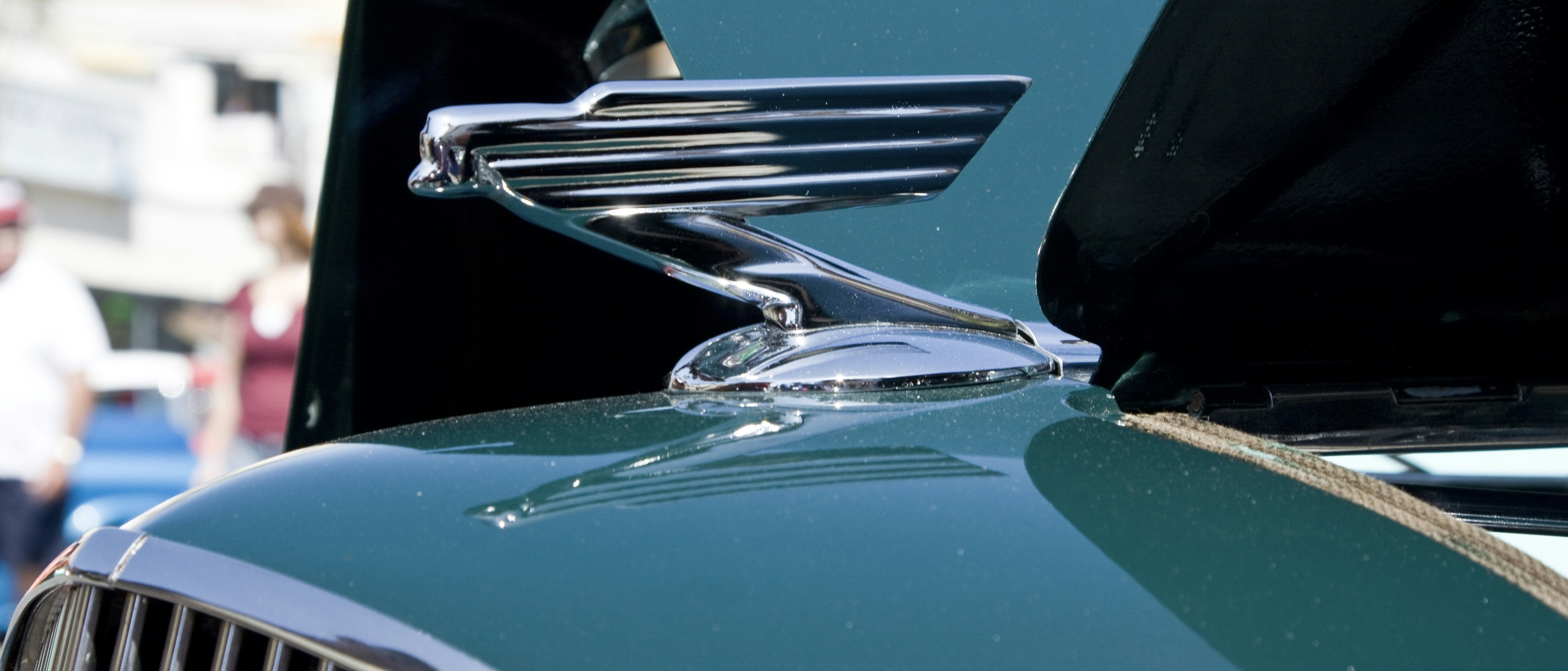 Chrome hood ornament and radiator cap on a classic car