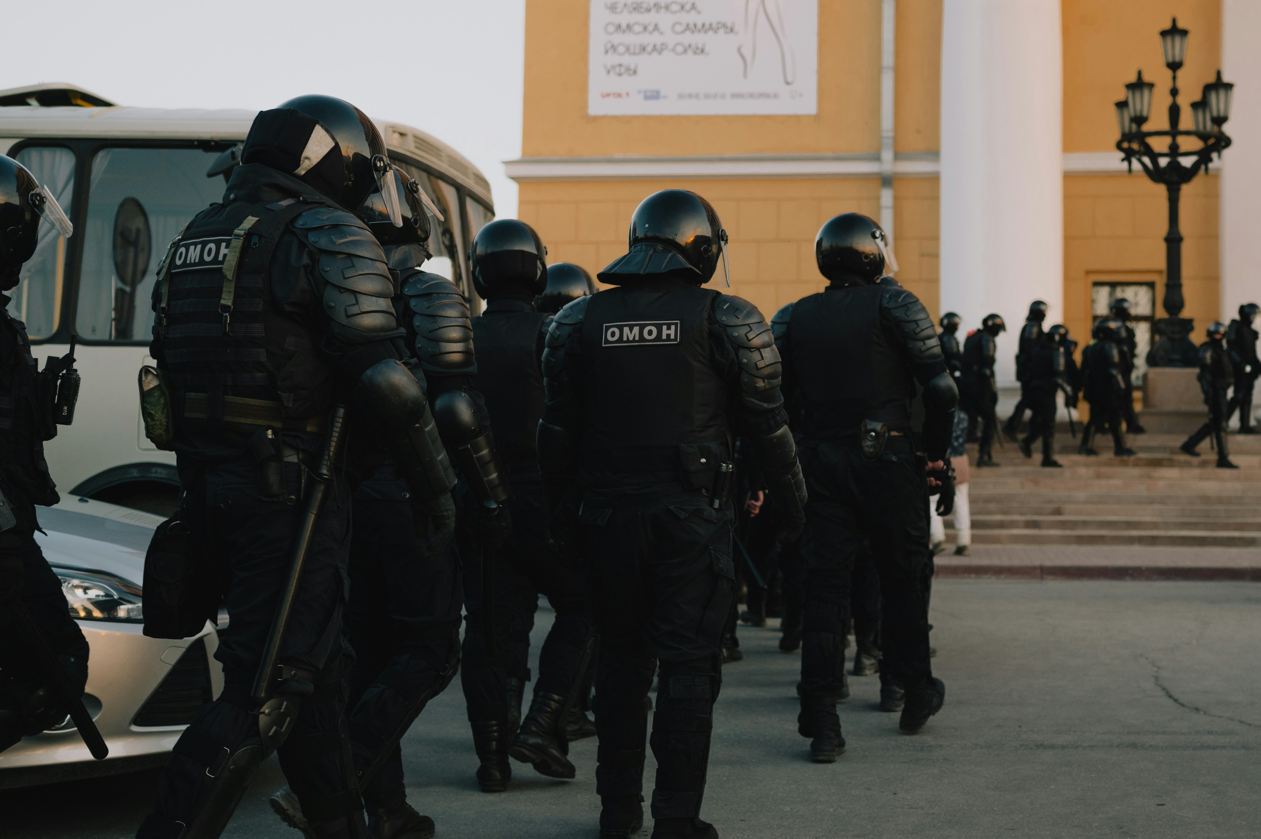 Group of police men in black uniform standing on gray concrete floor ...