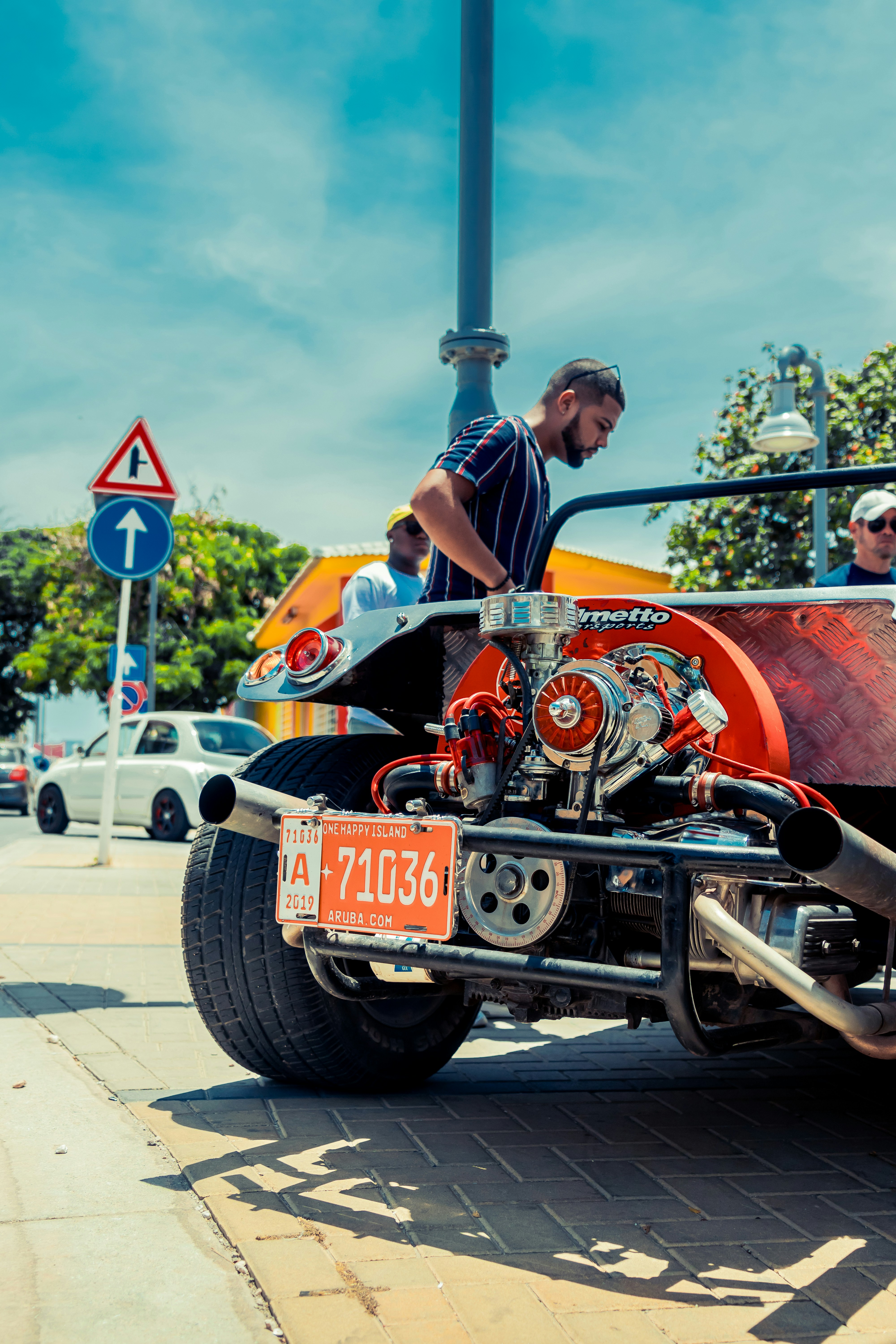 Noon on the Promenade: A Custom Hot Rod with Chrome Engine and Street-side Spectators