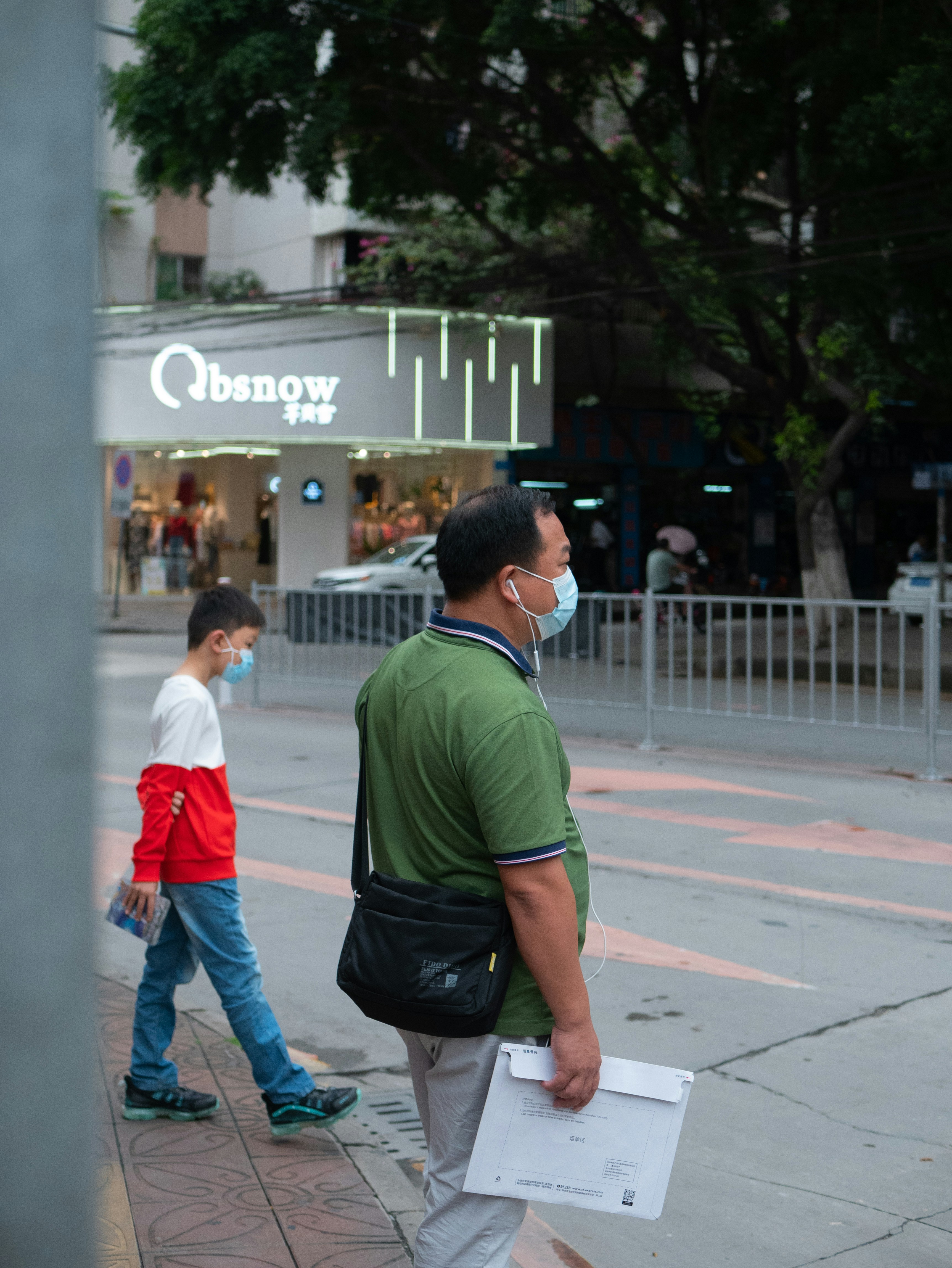Masked Messenger on a City Sidewalk with Papers in Hand