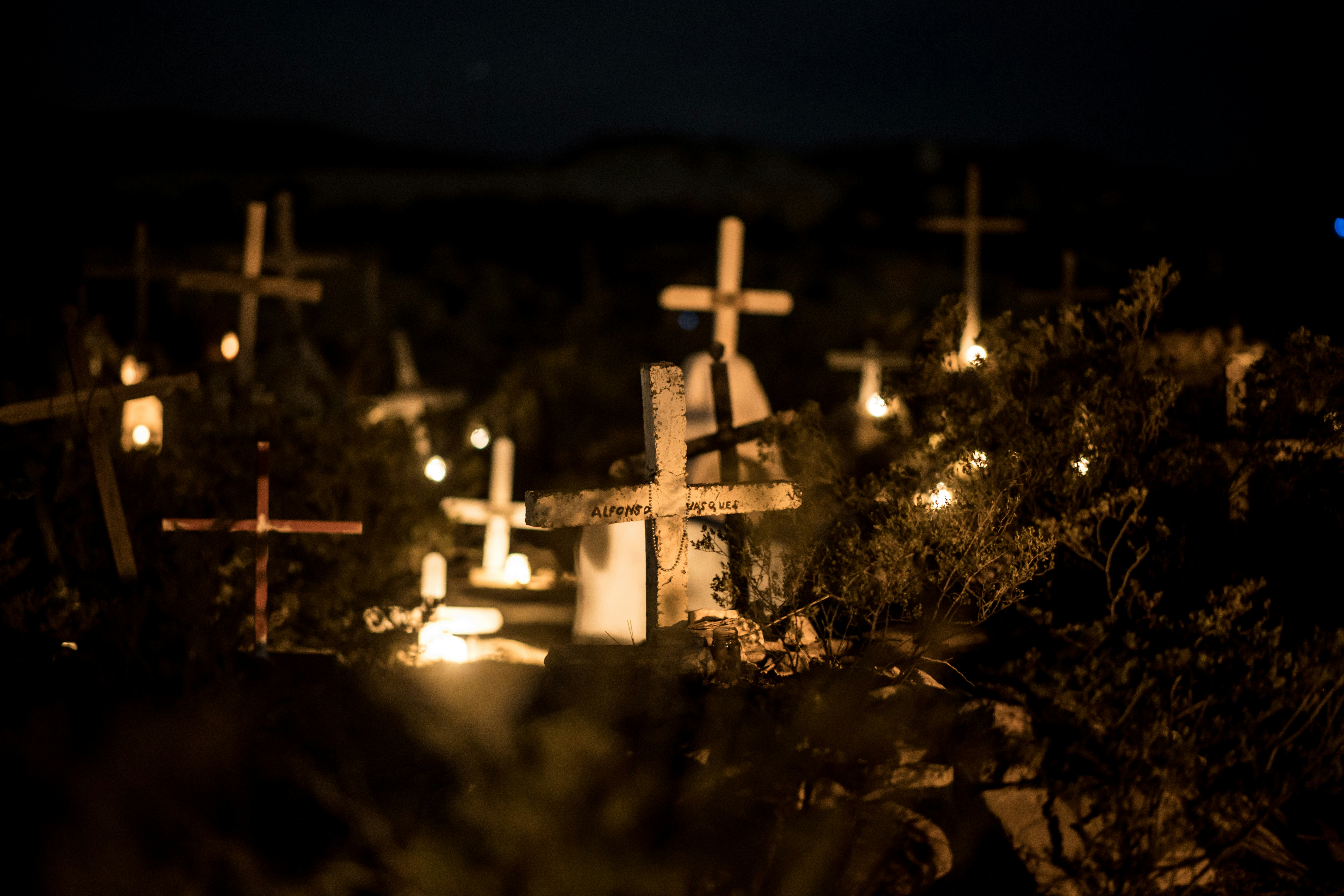 Candlelit Crosses in a Desert Cemetery at Night