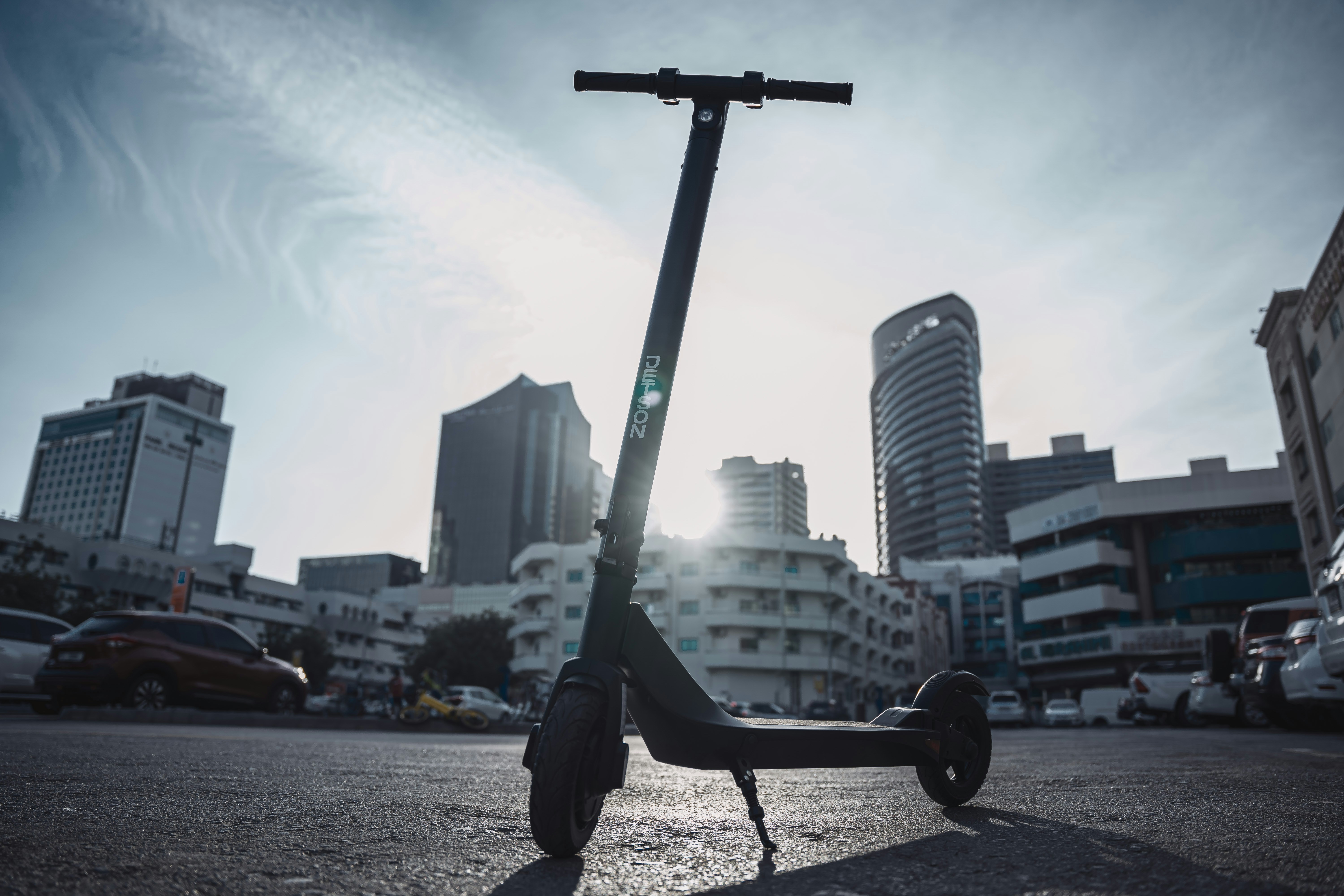 black bicycle near body of water and city buildings during daytime