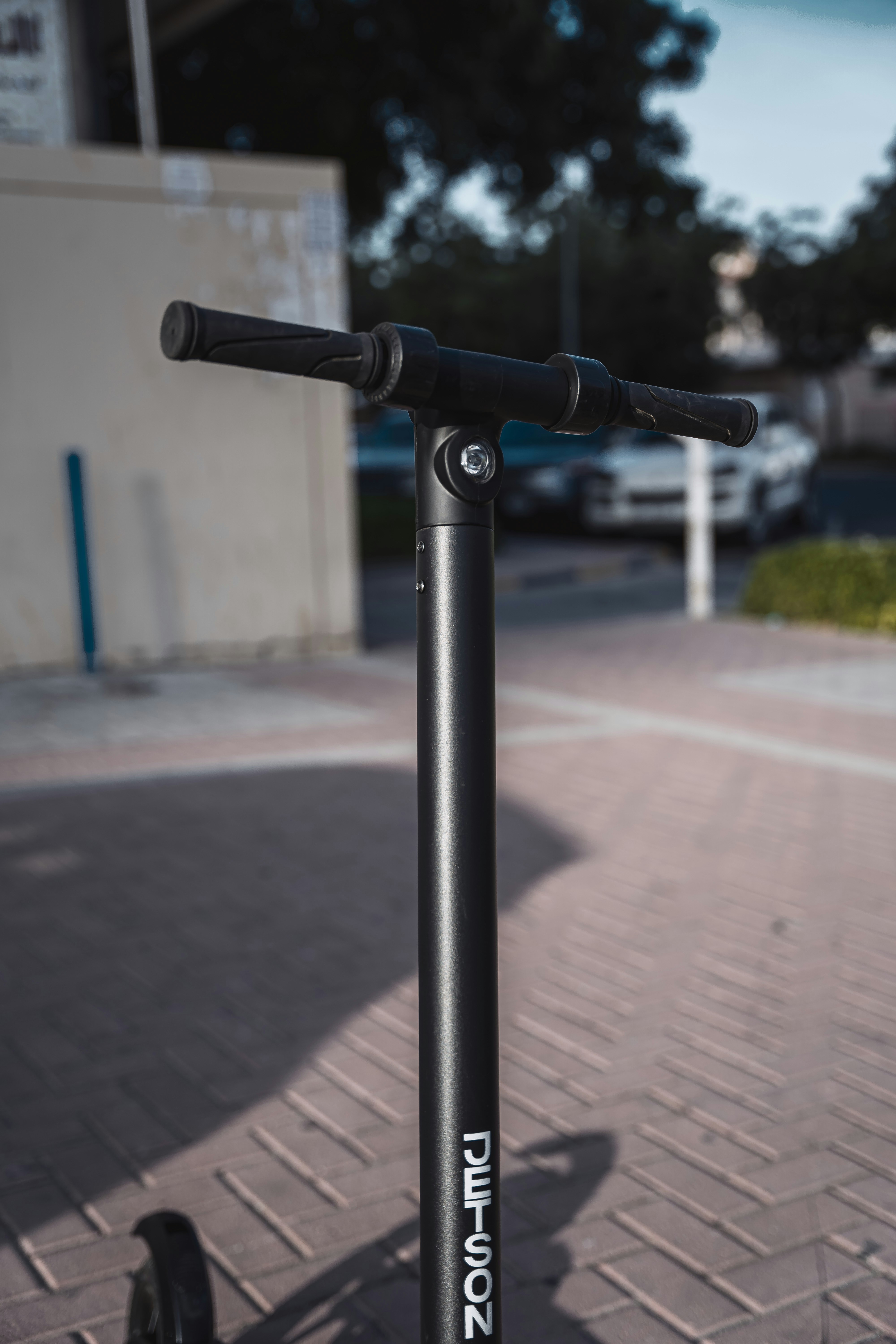 Pole in Focus: A Close-Up of a Night-Stroke Scooter
