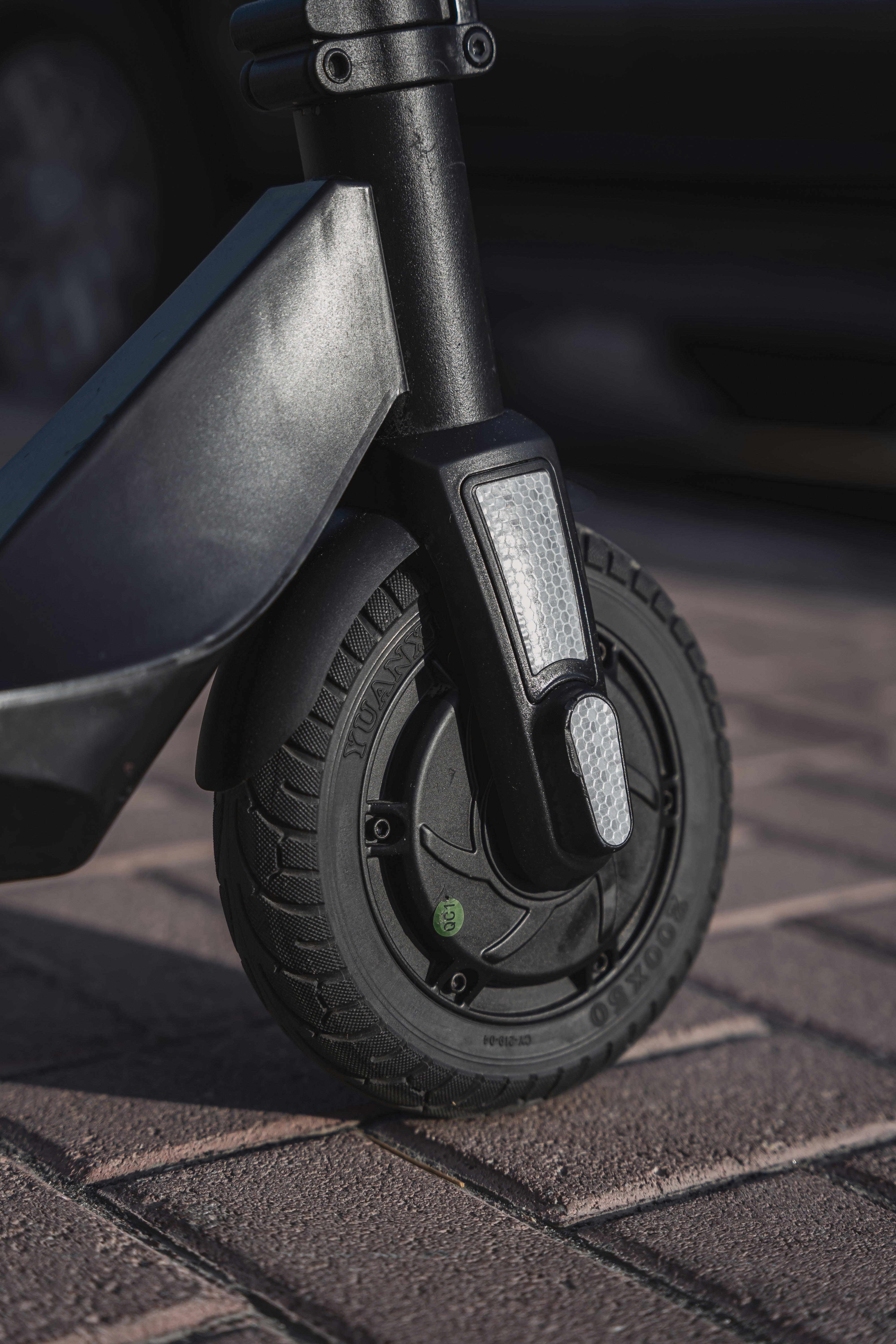 Close-Up of a Sturdy Kickstand Scooter Wheel in Urban Light
