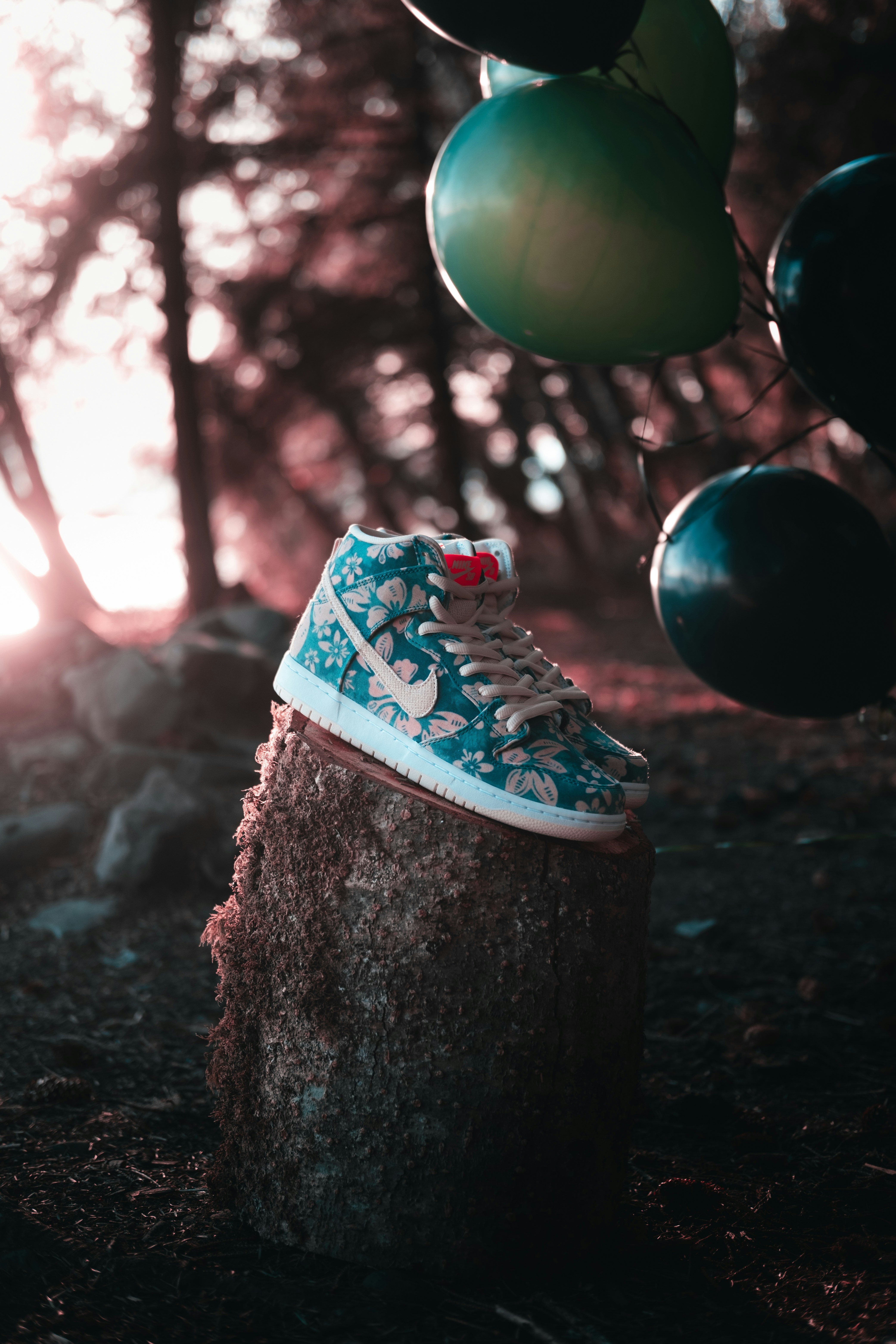Floral high-top on a stump beneath drifting balloons at dusk