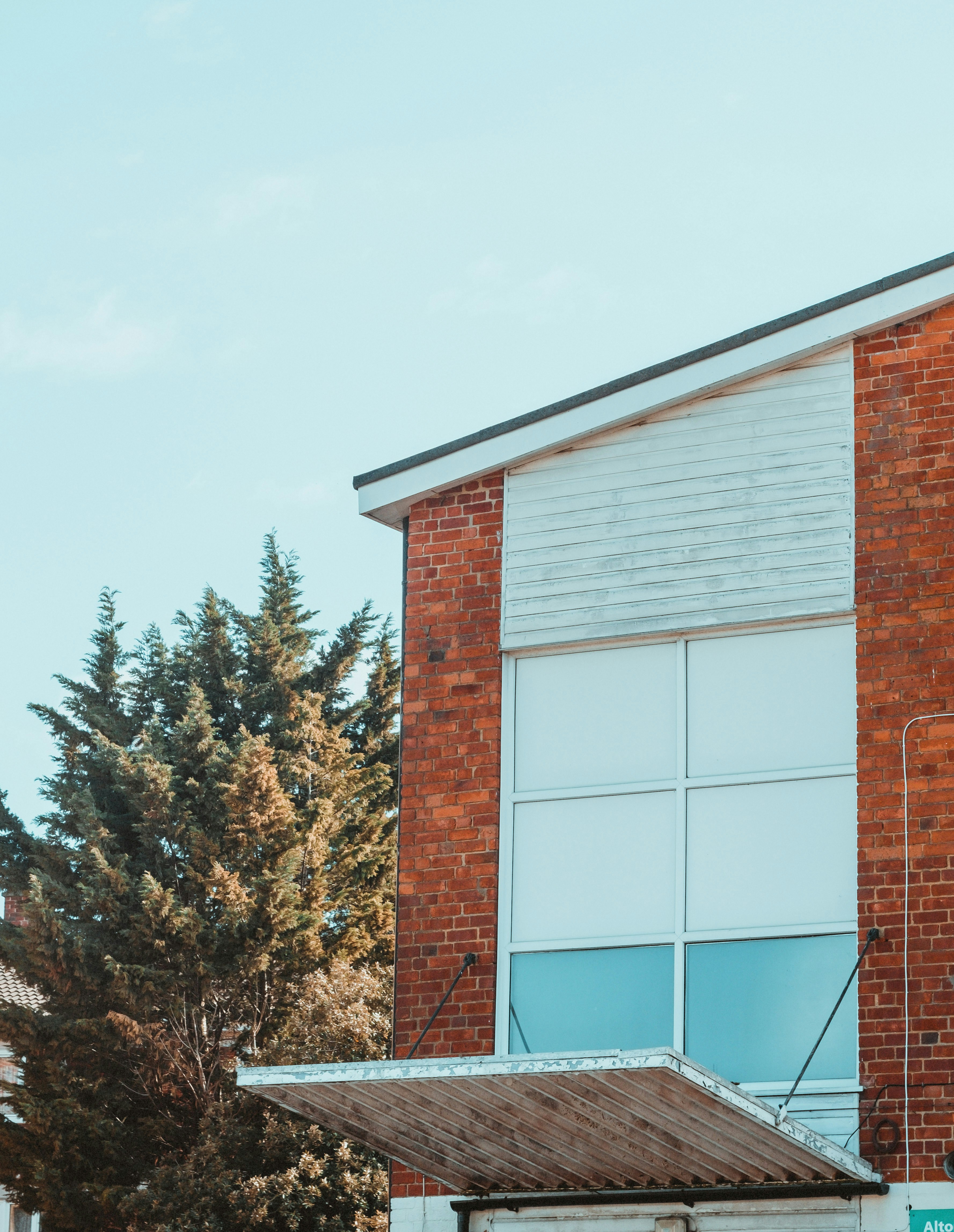 Brown brick building near green trees during daytime photo – Free Blue ...