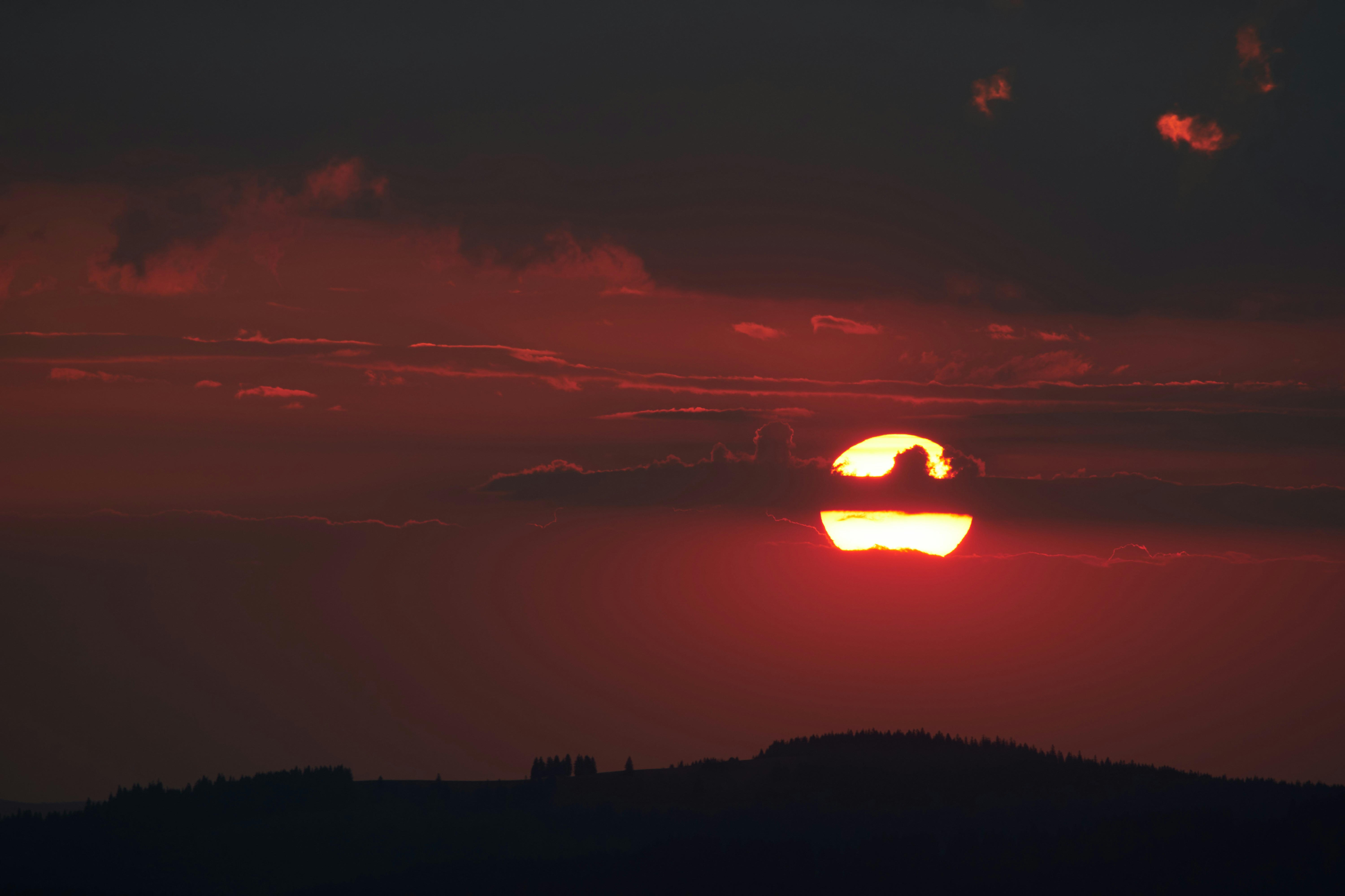 Halved Sun over a Quiet Ridge at Dusk