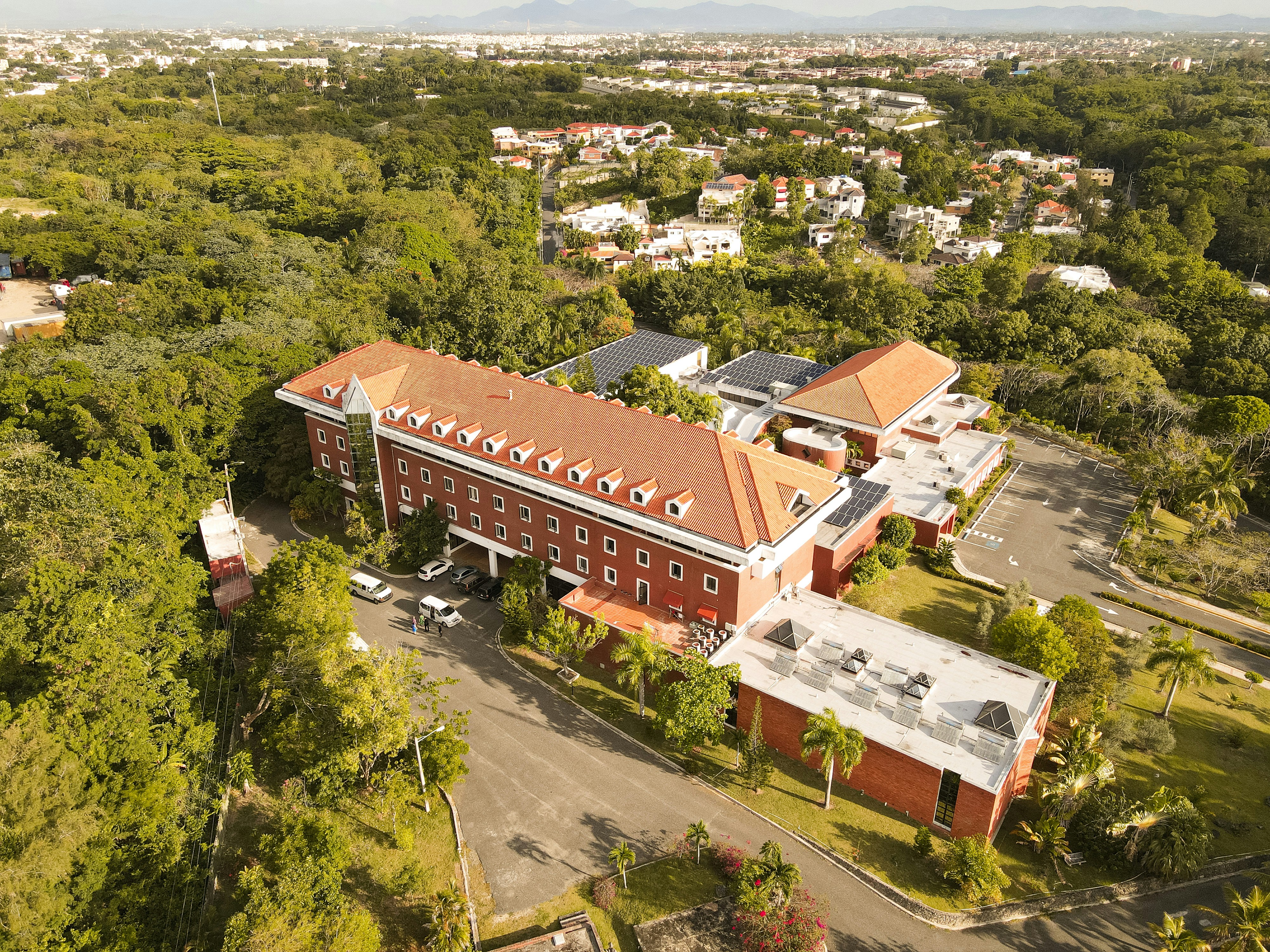 Historic building surrounded by lush greenery in an urban setting, showcasing a blend of architecture and nature.