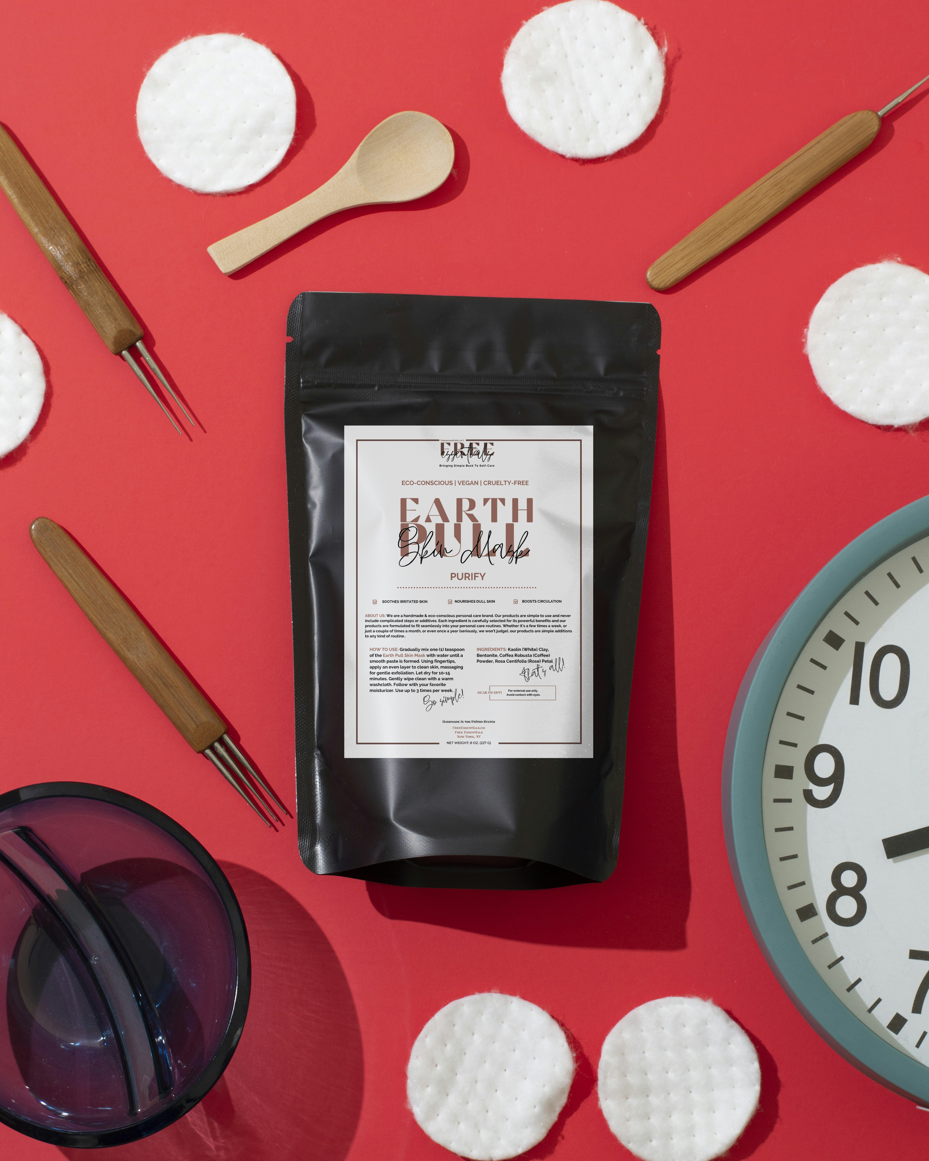 A stylish package of 'Earth' product surrounded by kitchen tools and cotton pads on a vibrant red background.