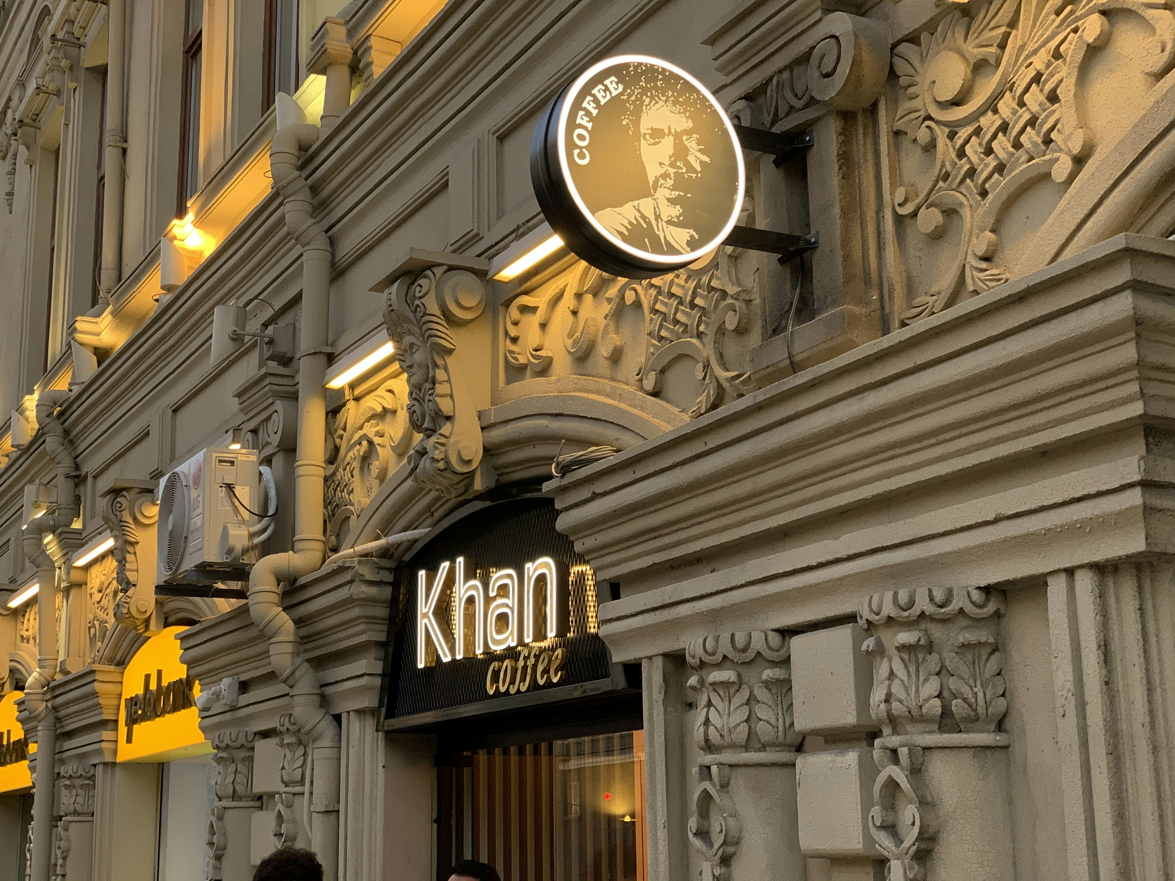 Ornate architectural details on a building facade with warm illuminated signage.