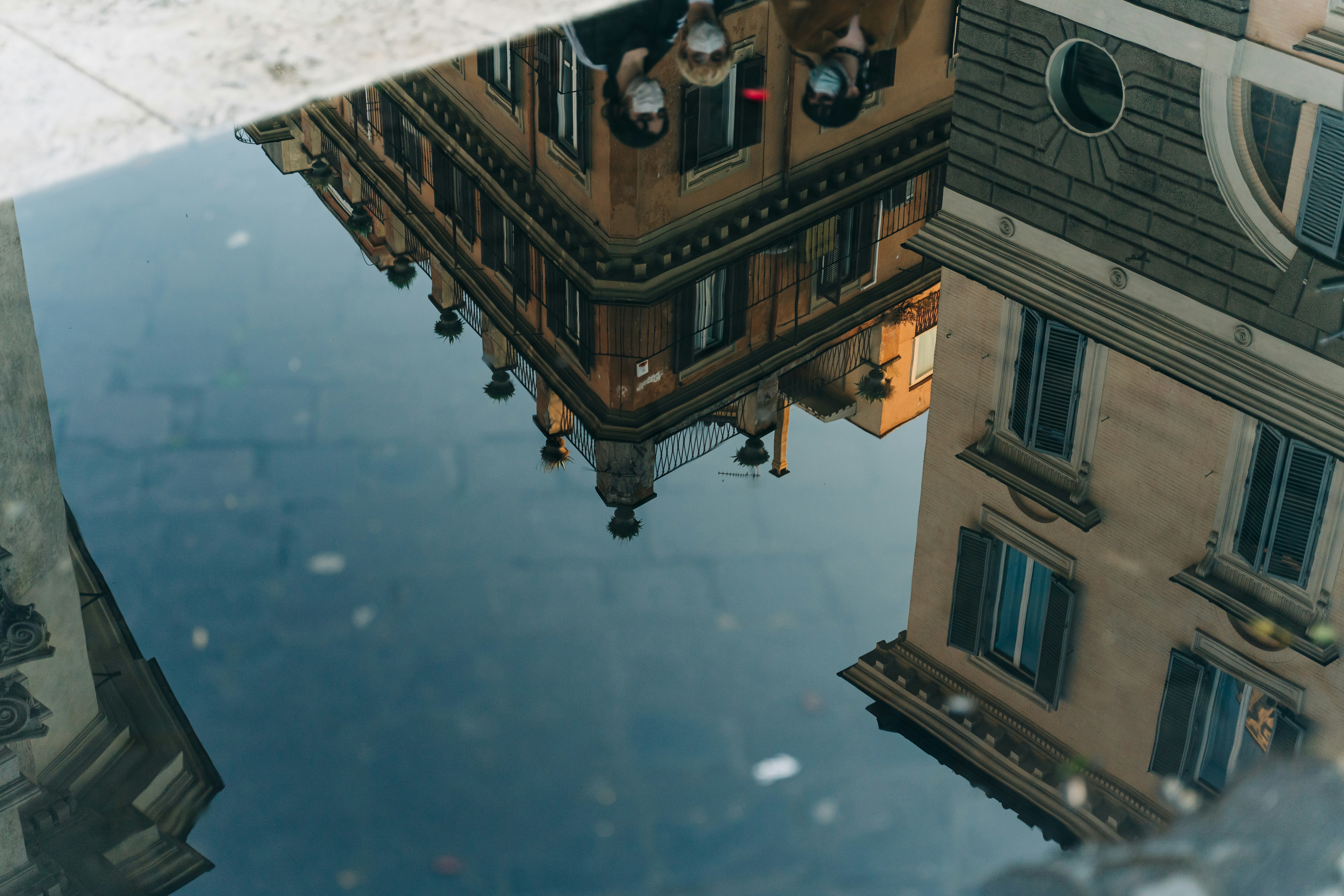Inverted Cityscape Reflected in a Quiet Puddle