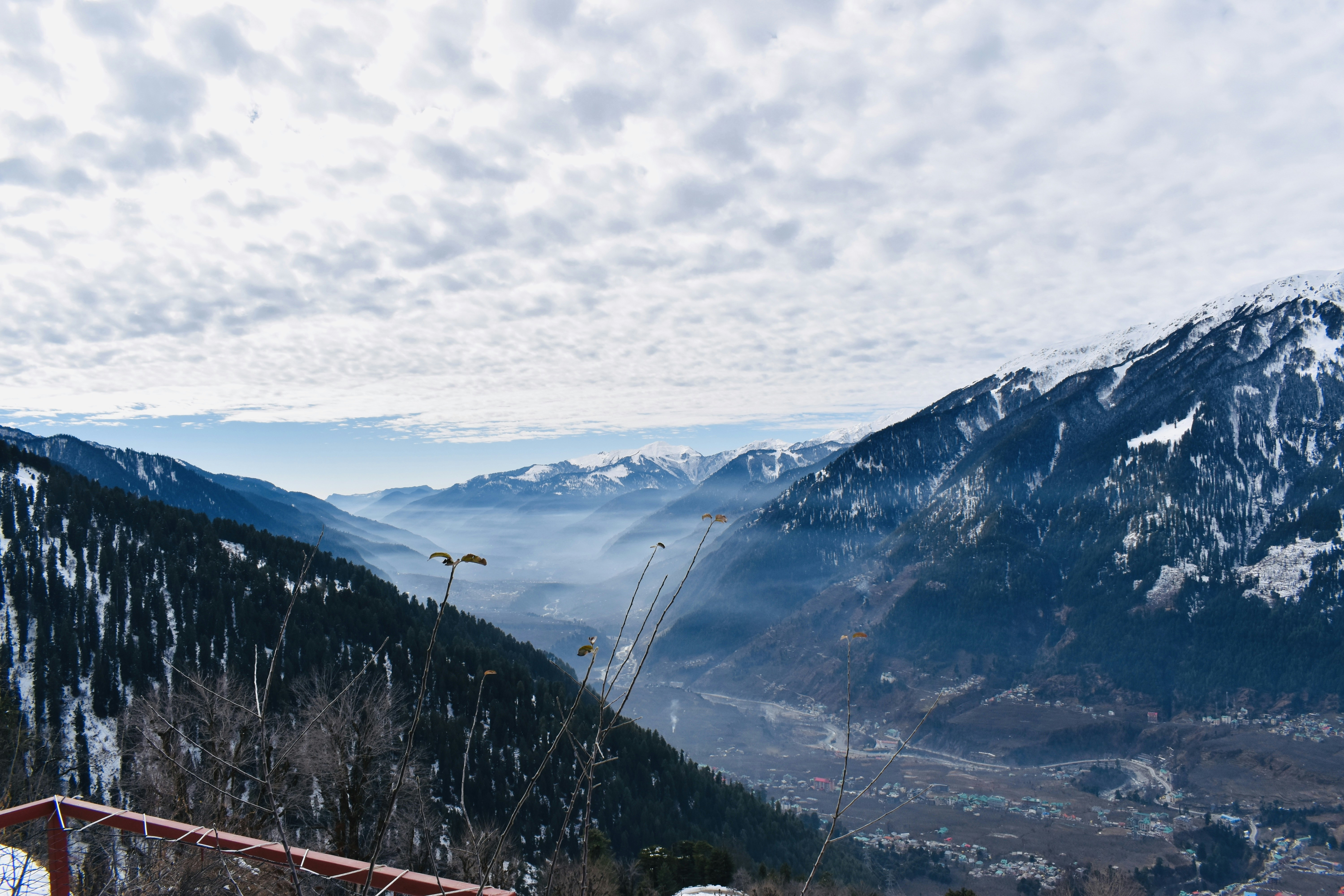 Ridge Overlook: Snow-Dusted Valleys and a Distant Town