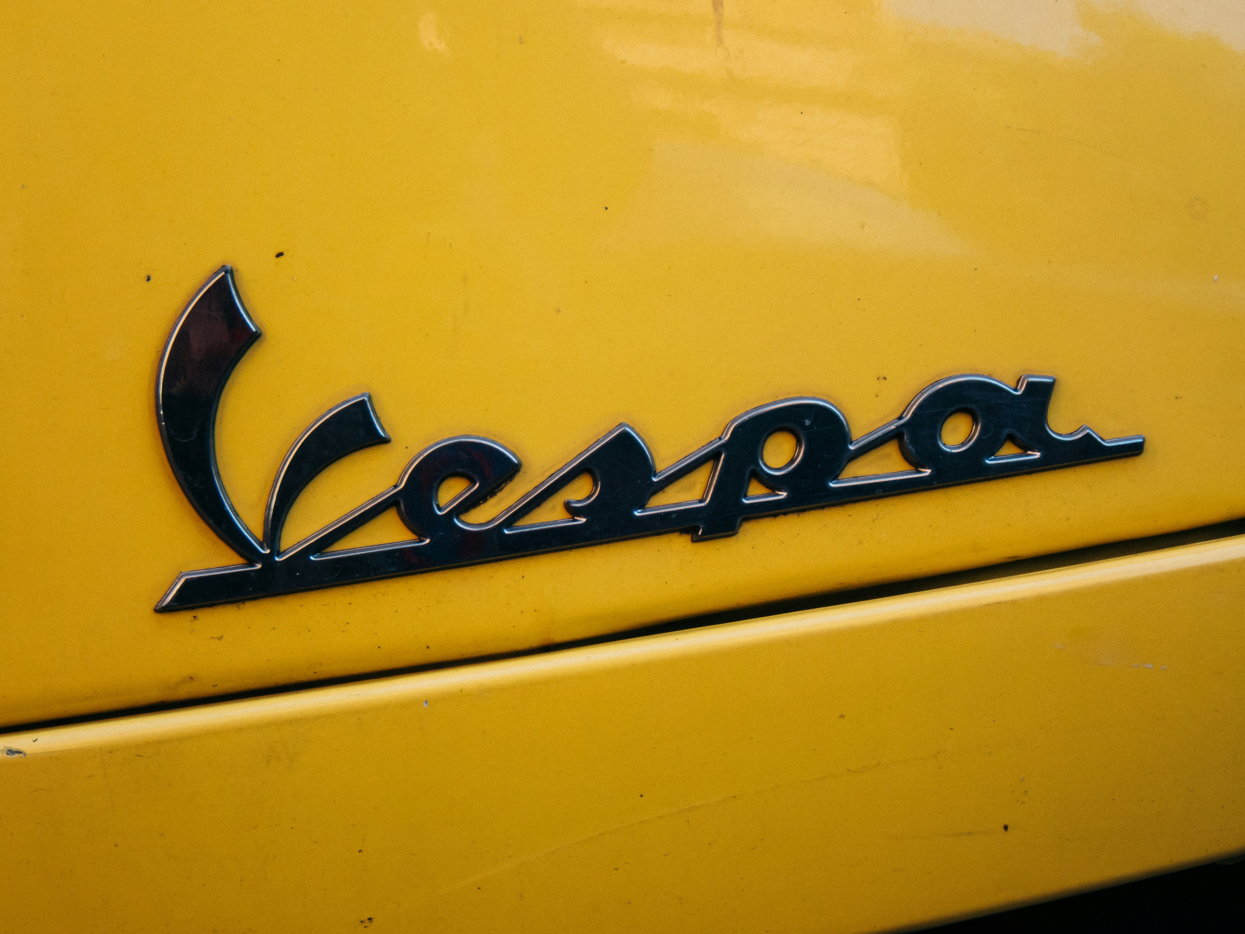 Vespa in Yellow: A Close-Up of the Classic Script