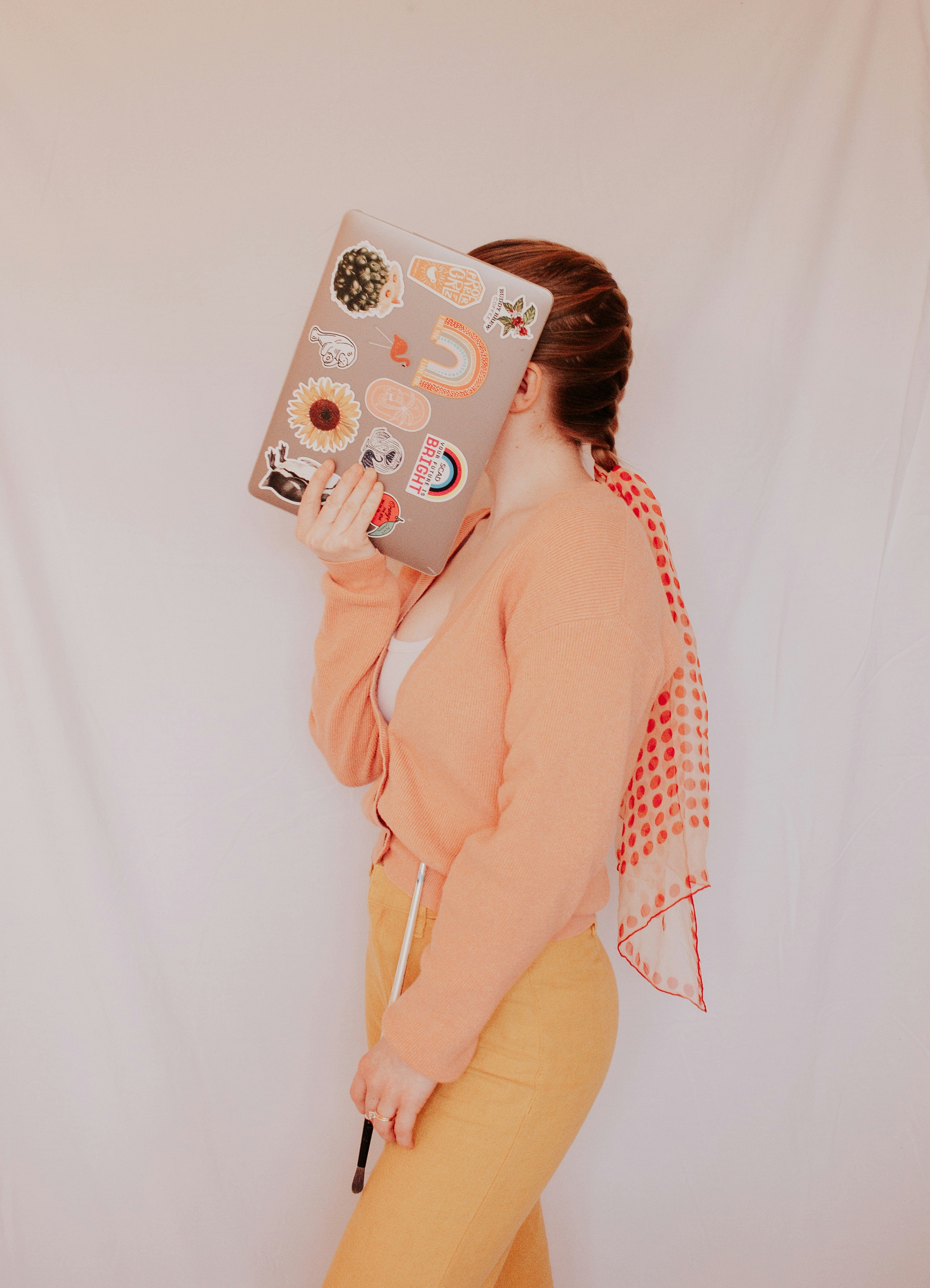 Stickered Laptop Mask in a Peach Studio Portrait
