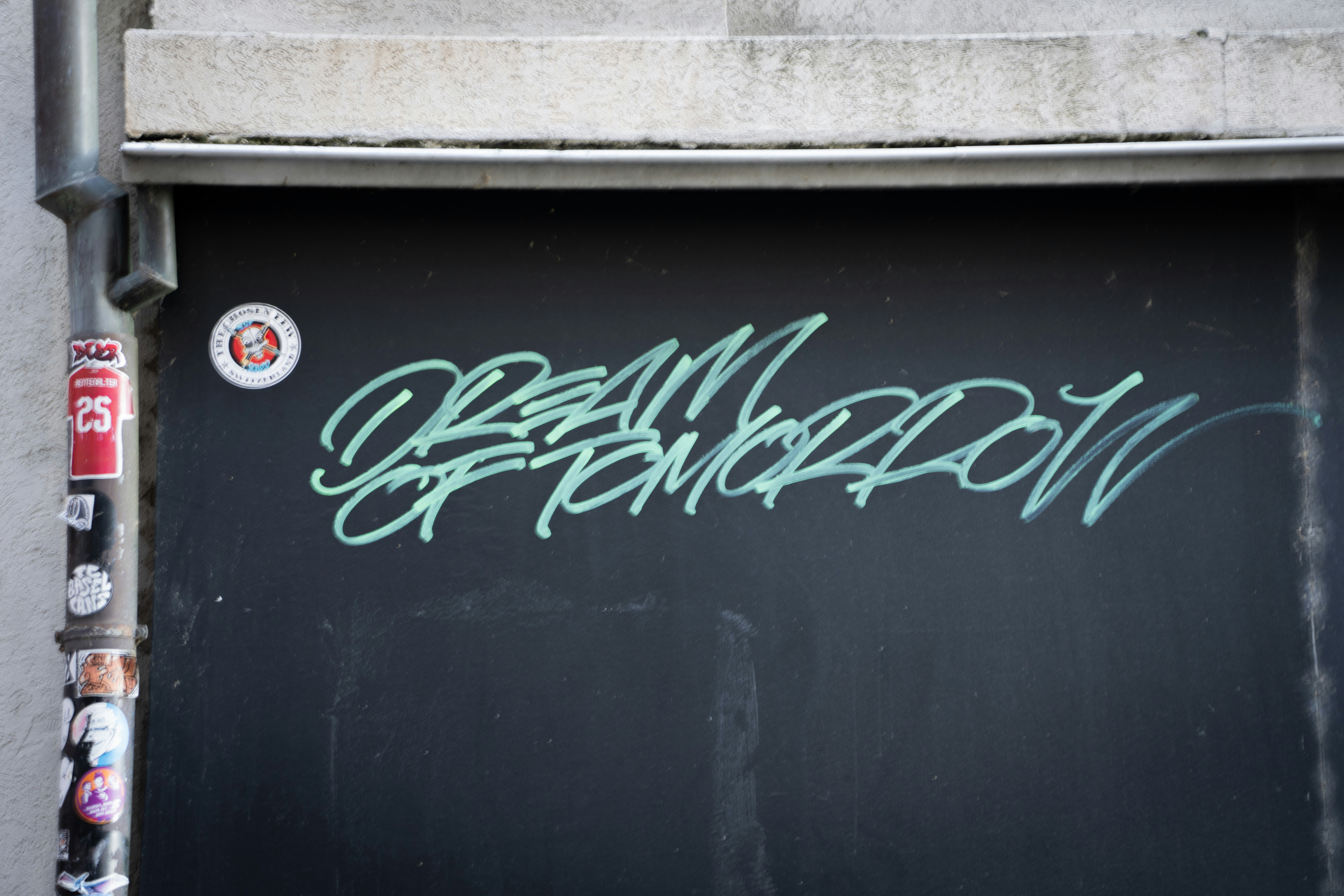 Turquoise Dream Script on a Weathered Door: An Urban Graffiti Moment