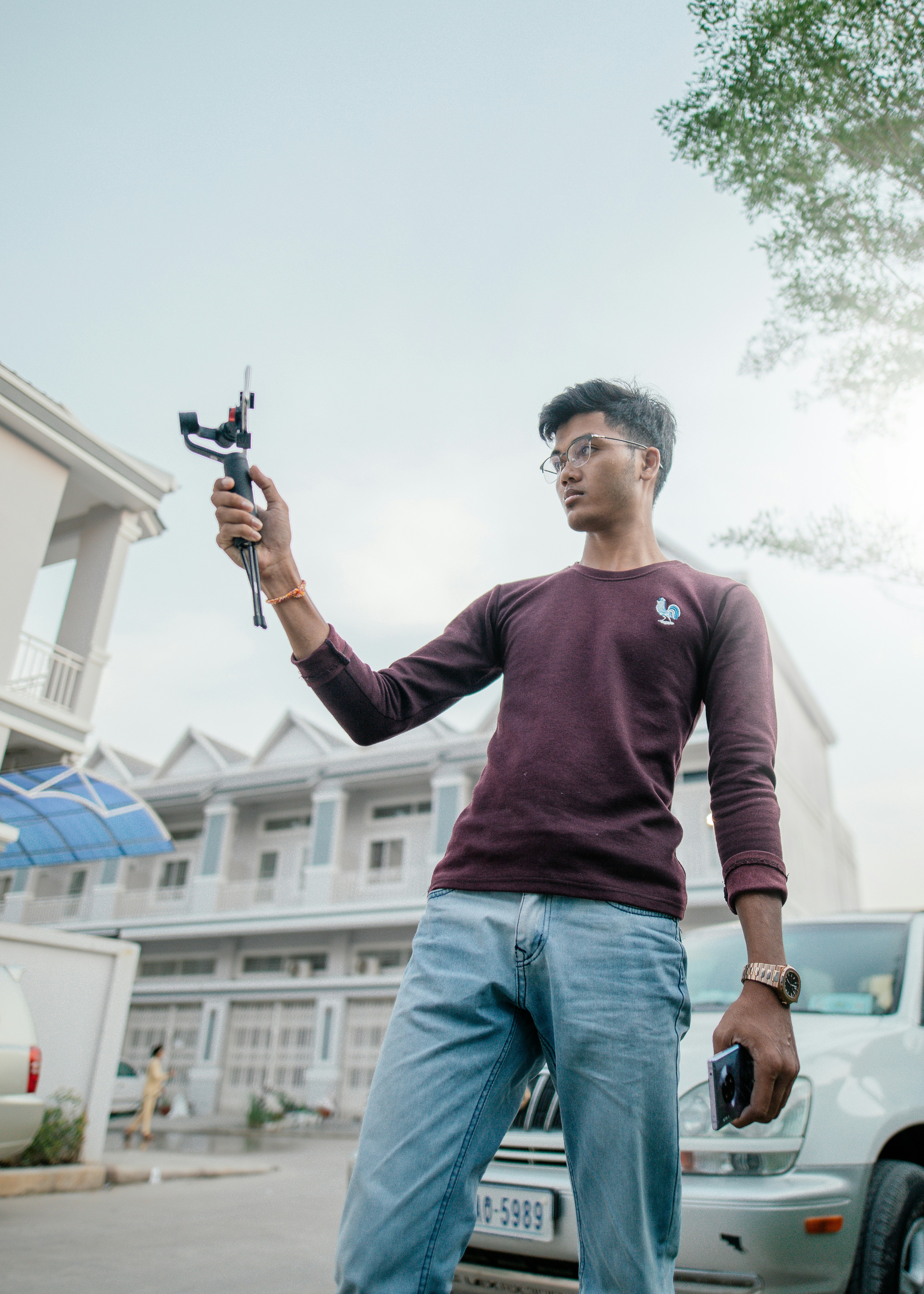 Man in maroon long sleeve shirt holding black smartphone photo – Free ...