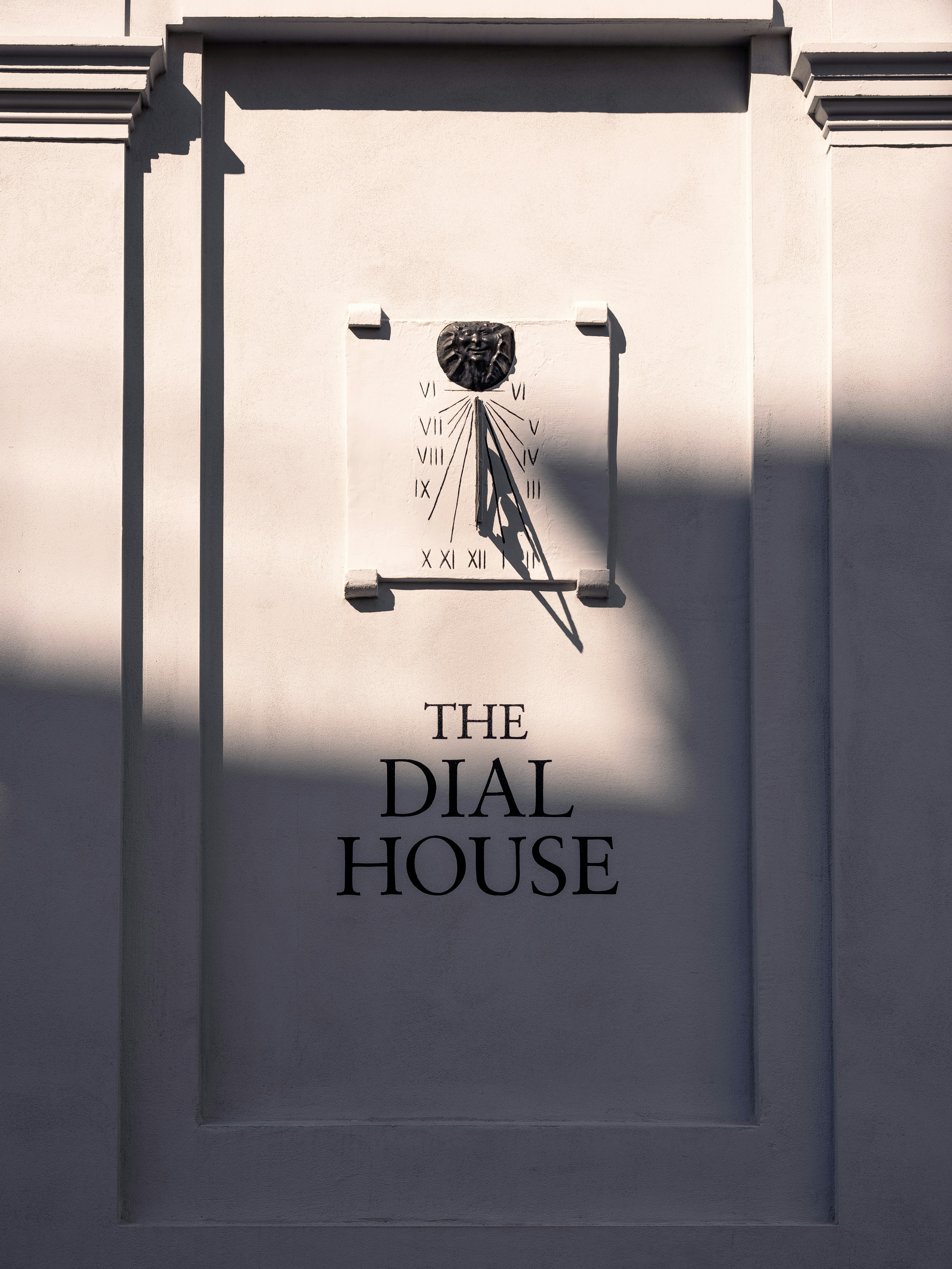 The dial house sign on the side of a building photo – Free Words Image ...